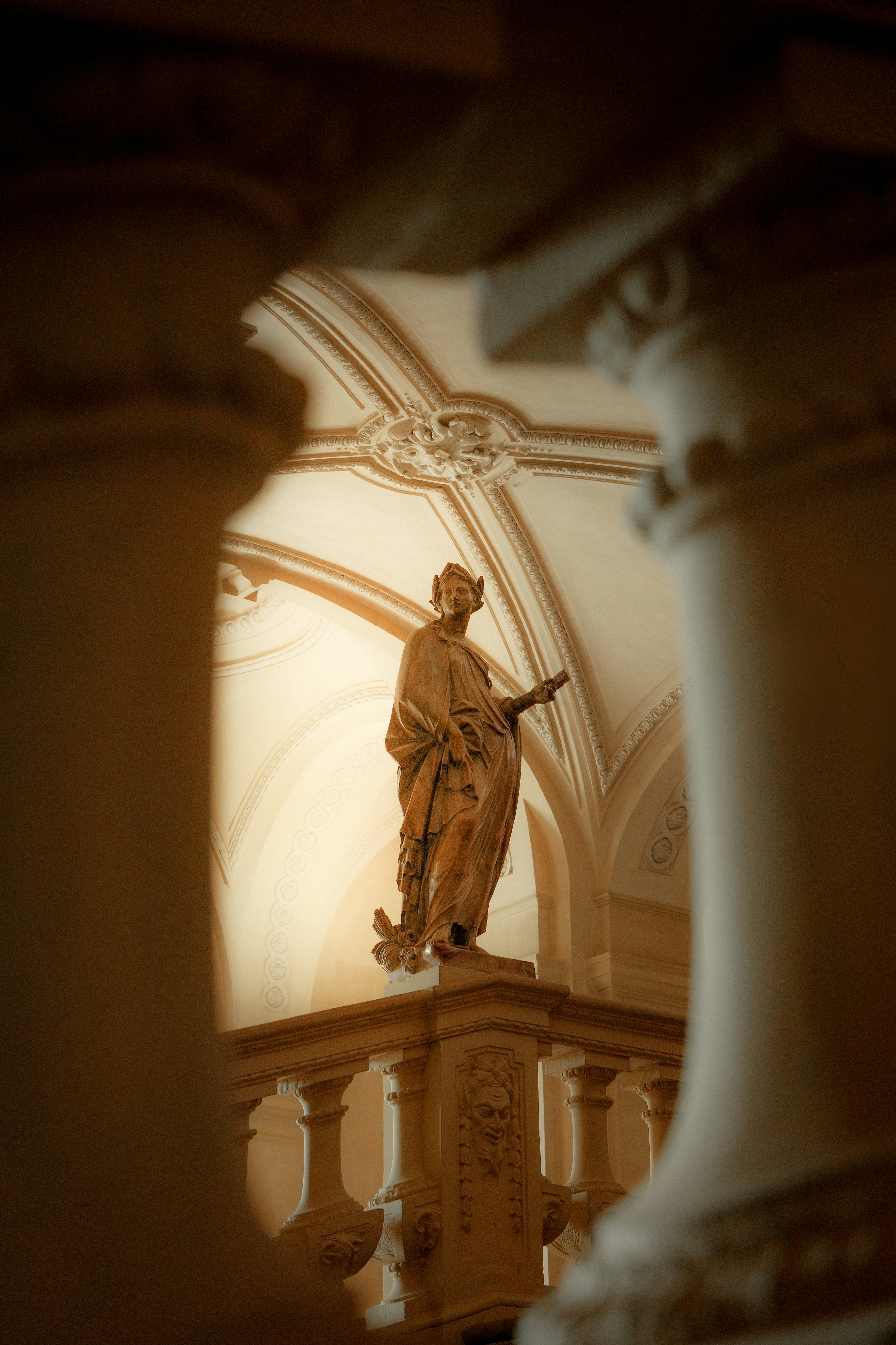 Statue Beneath Marble Arches: A Quiet Cathedral Balcony