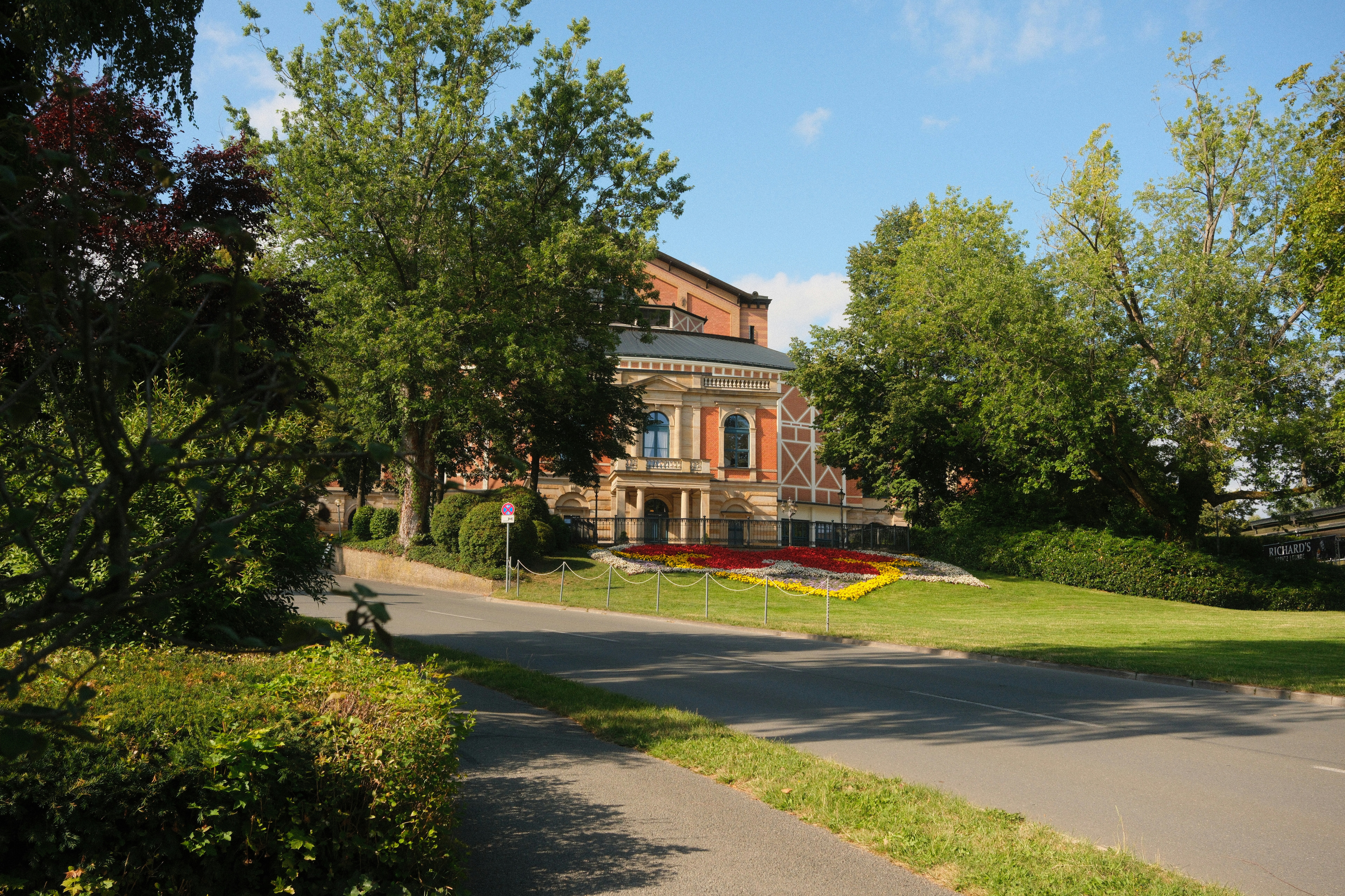 Brick Facade and Flowerbed Portal: A Tranquil Campus Corner