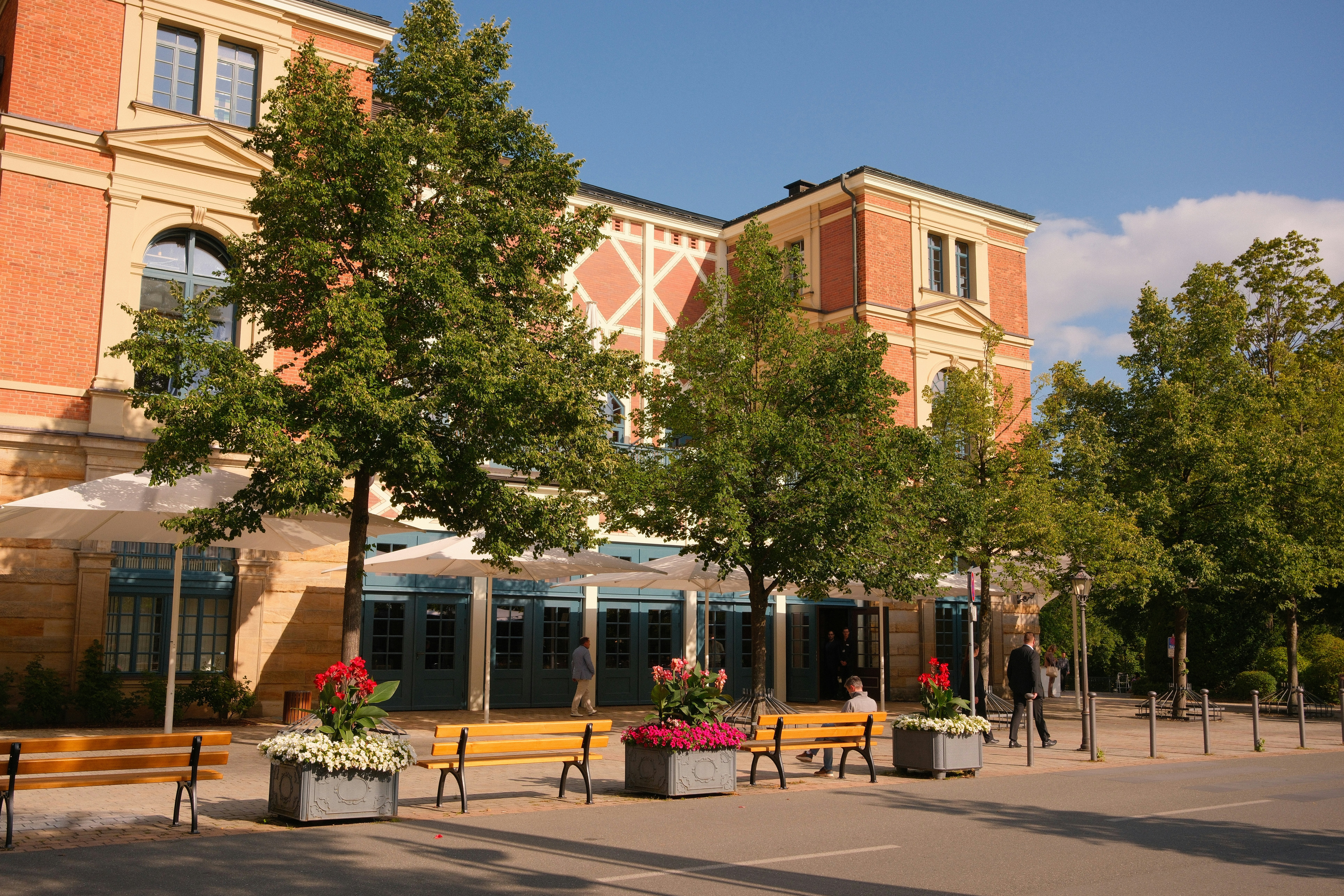 Facade of a Sunlit Campus Arcade with Planters and Trees
