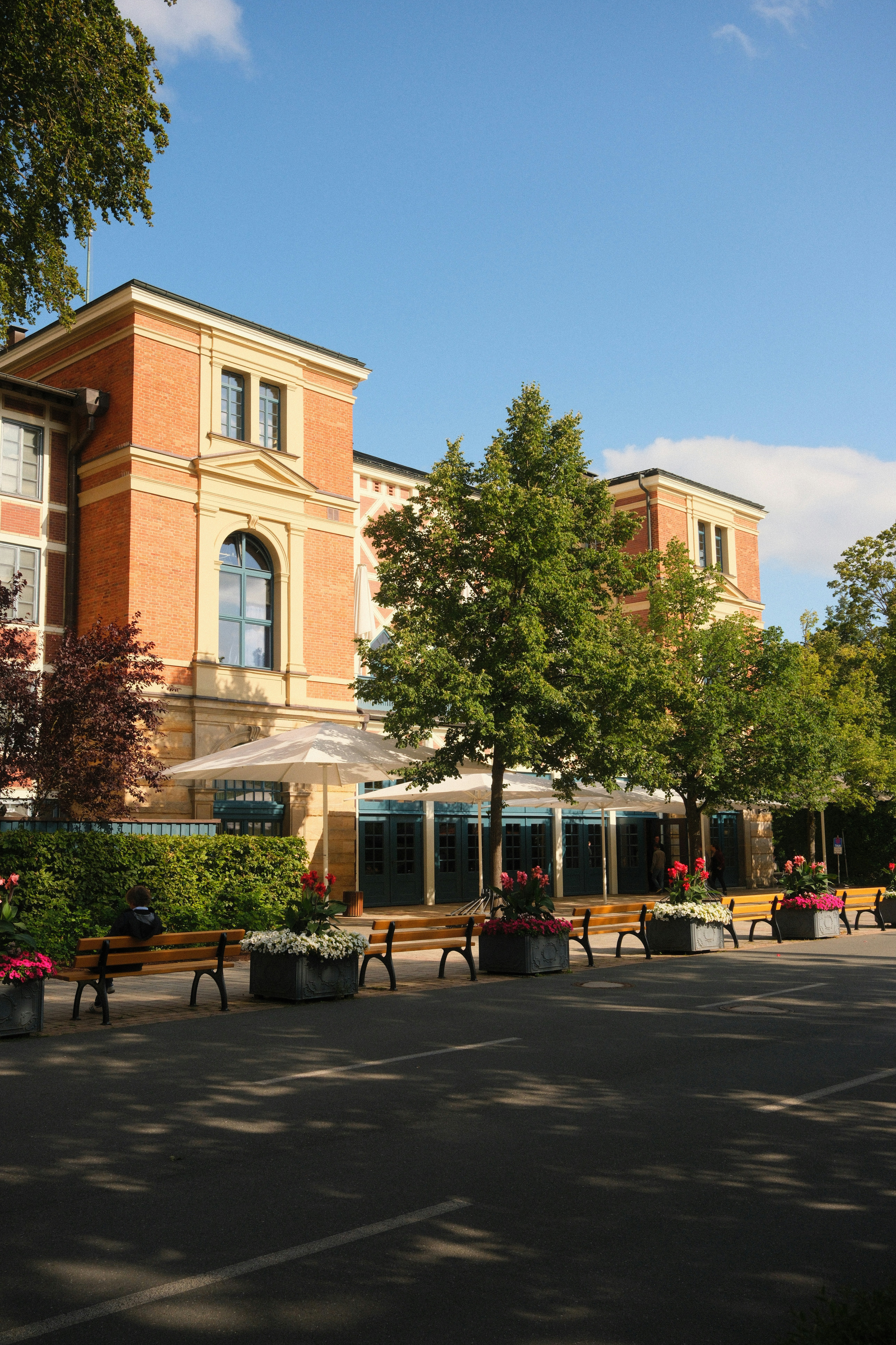 Brick Courtyard Facade Beneath a Canopy of Shade and Sky