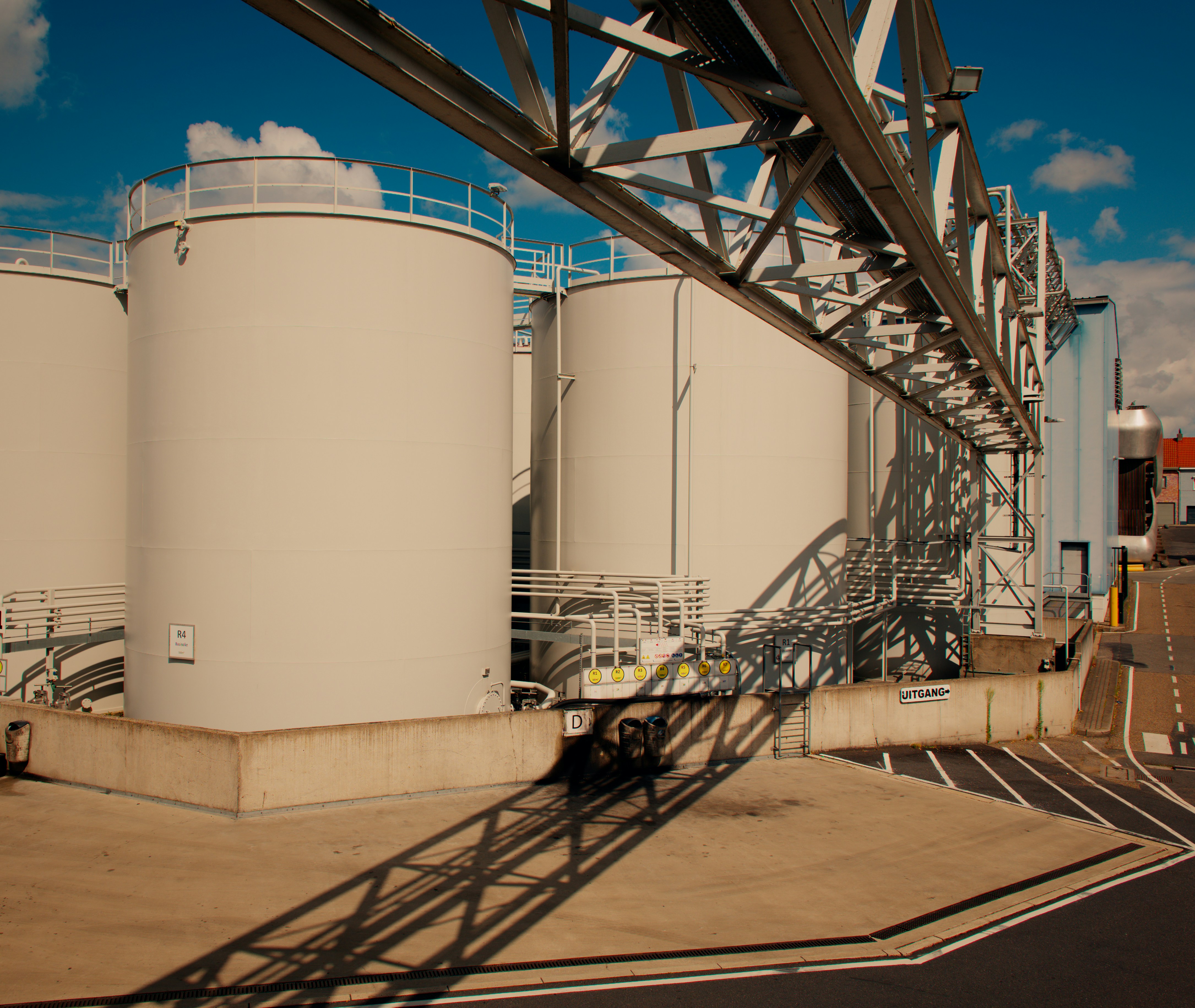Industrial Silhouette: Cylinders, Shadows, and a Traversing Girder