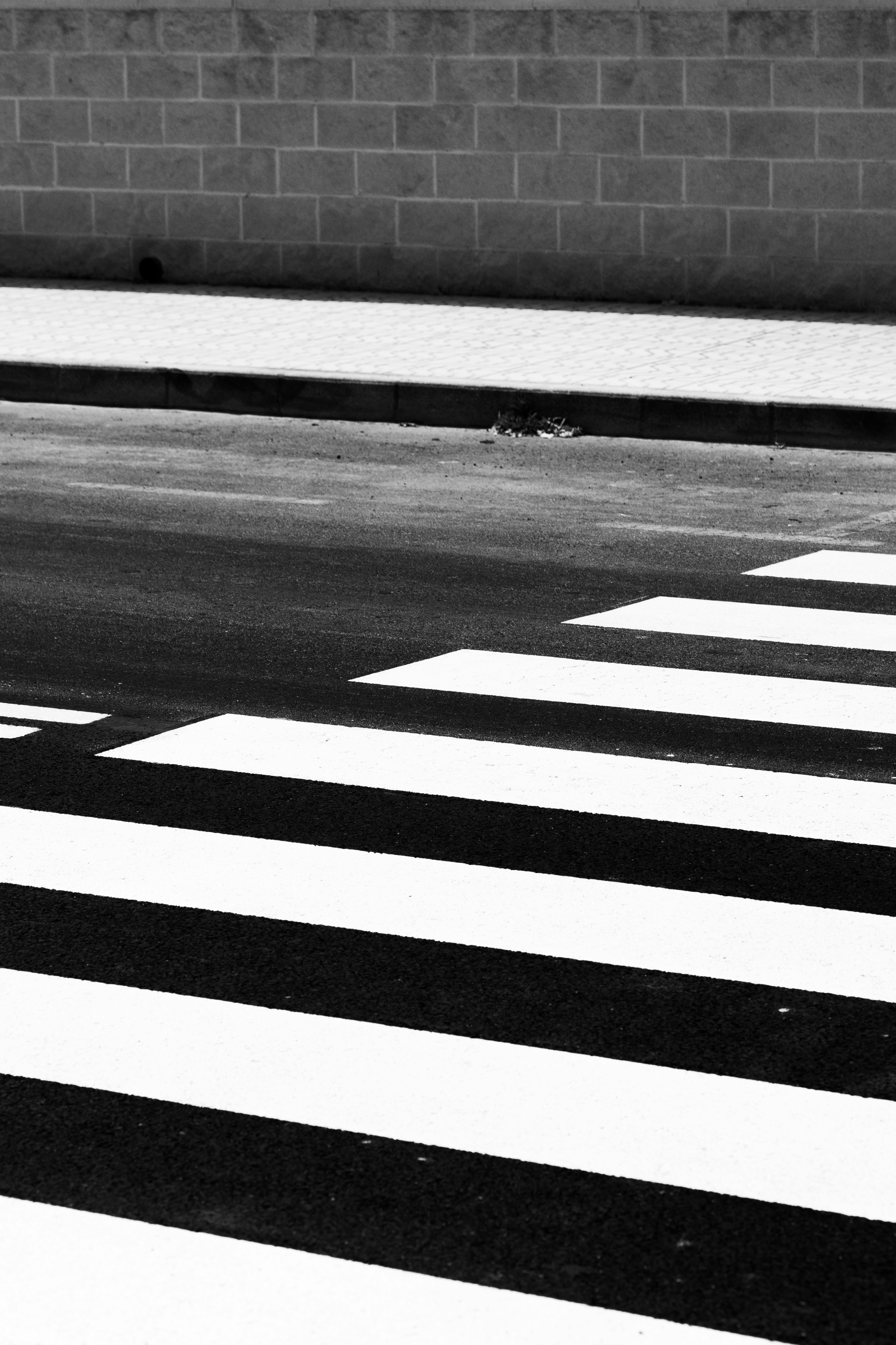 Contrasting Stripes: A Quiet Street Crossing in Monochrome
