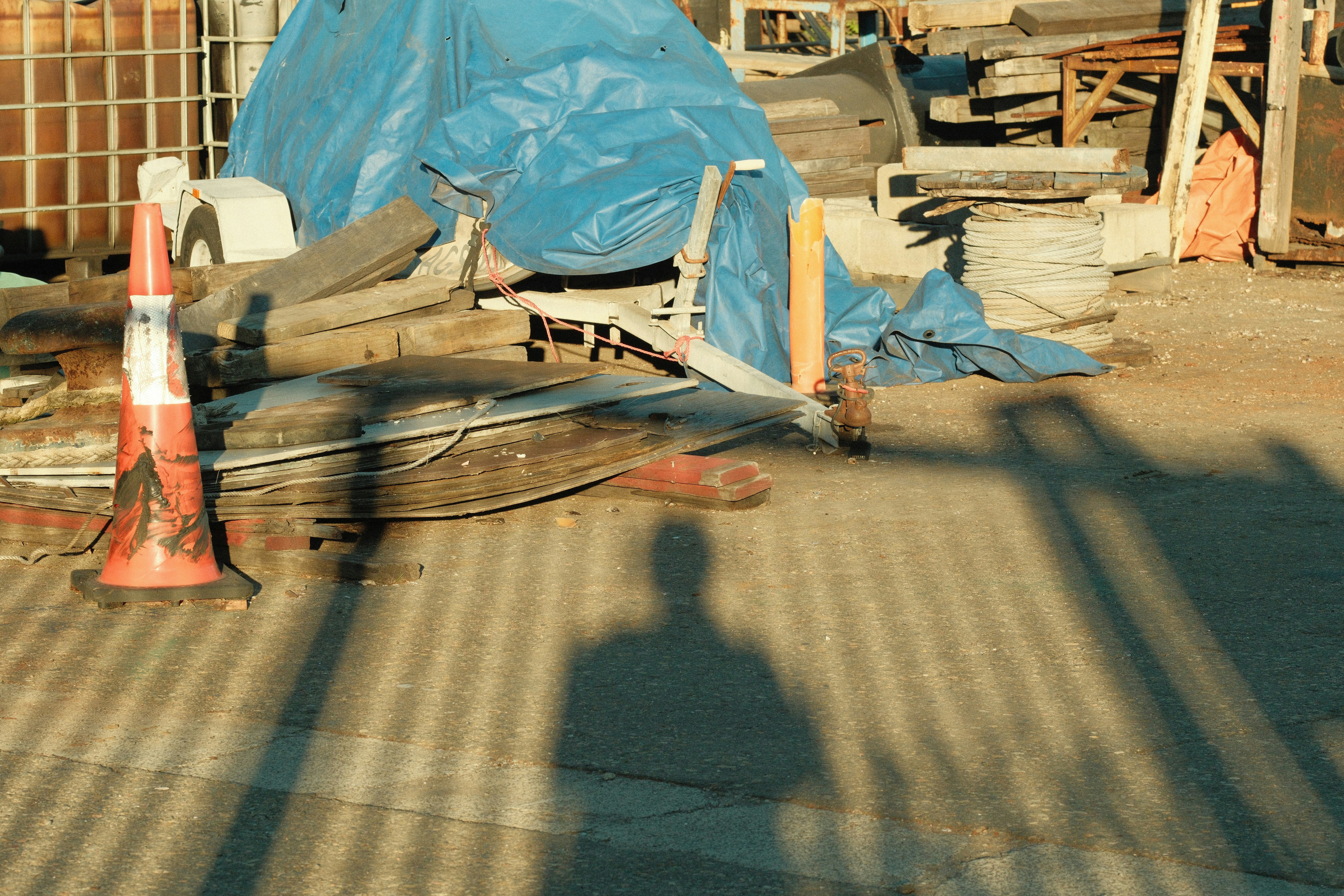 Shadowed Worker silhouette over a cluttered construction yard