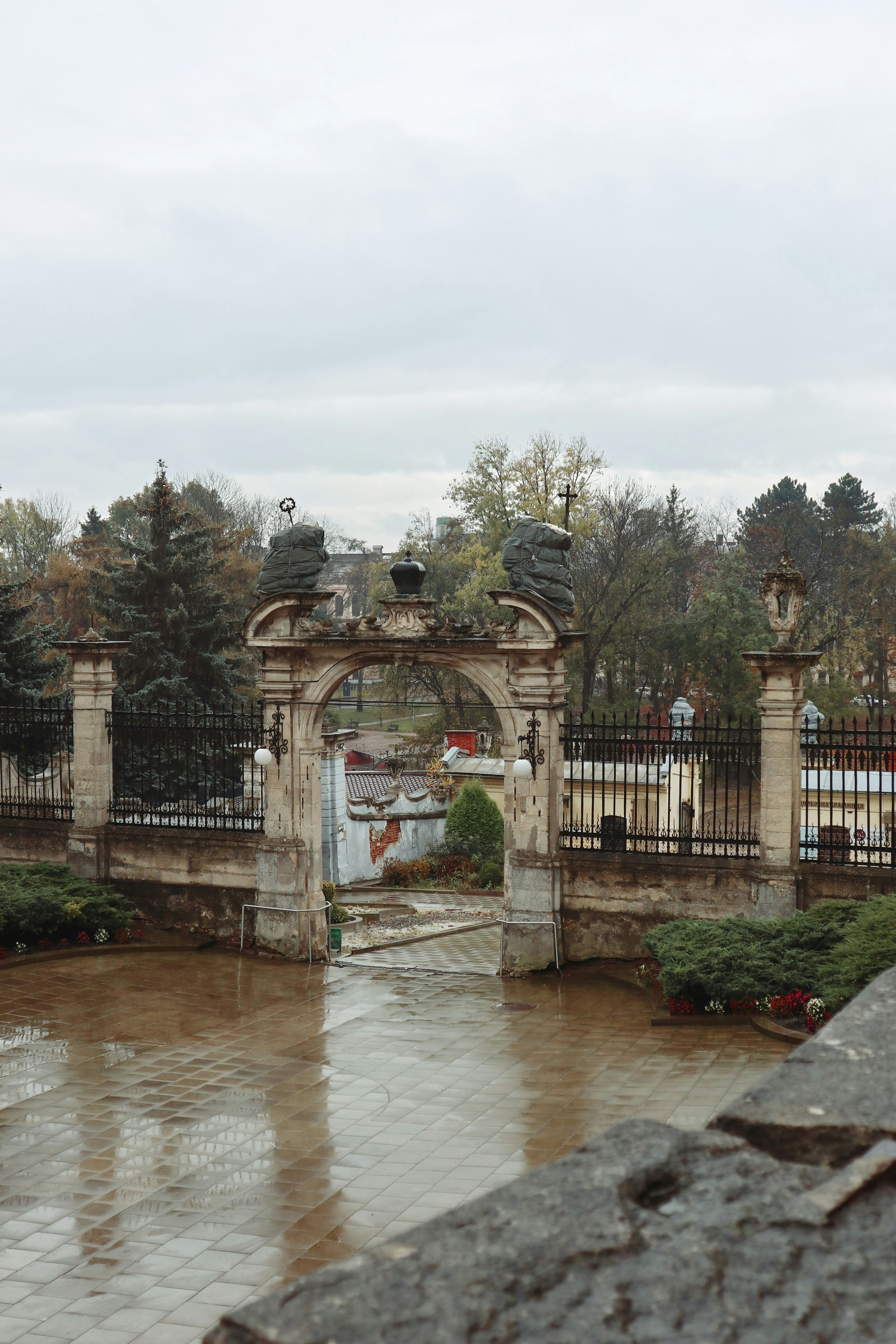 Stone Entrance Archway Framed by Wet Courtyard After Rain