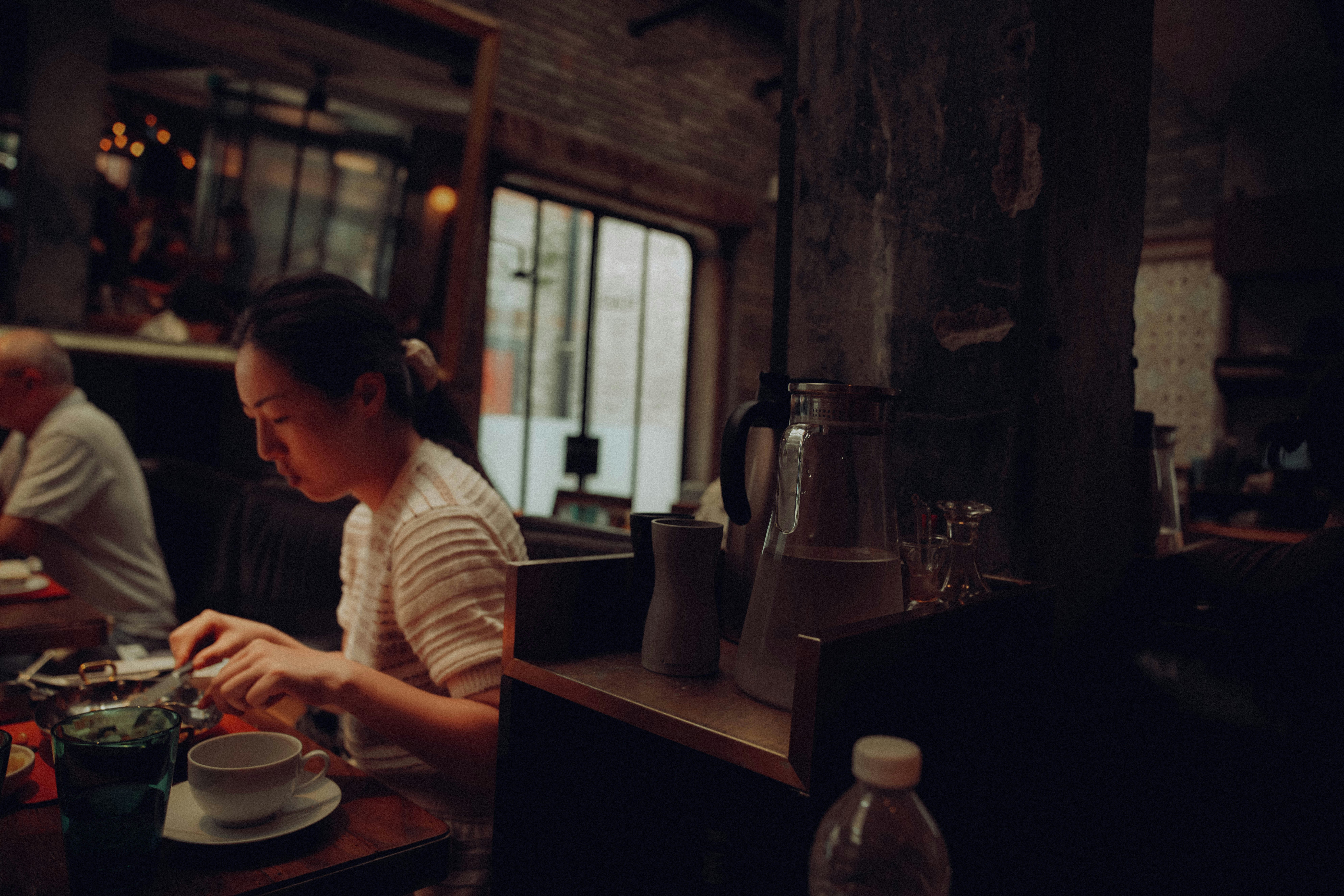 Quiet Focus at the Table: A Solo Moment in Soft Café Light
