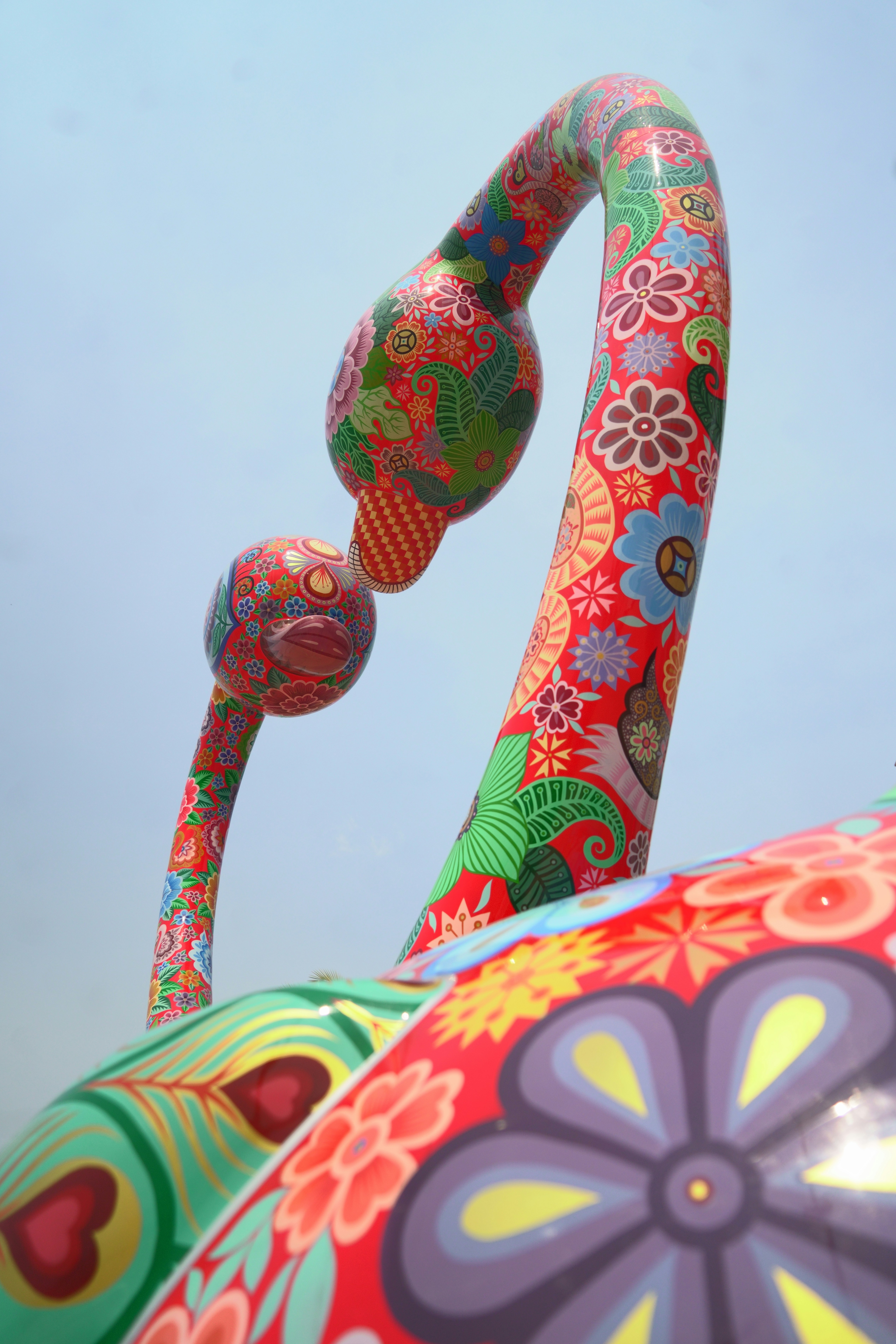 Vivid carnival curves: A close-up of patterned amusement sculptures reaching skyward