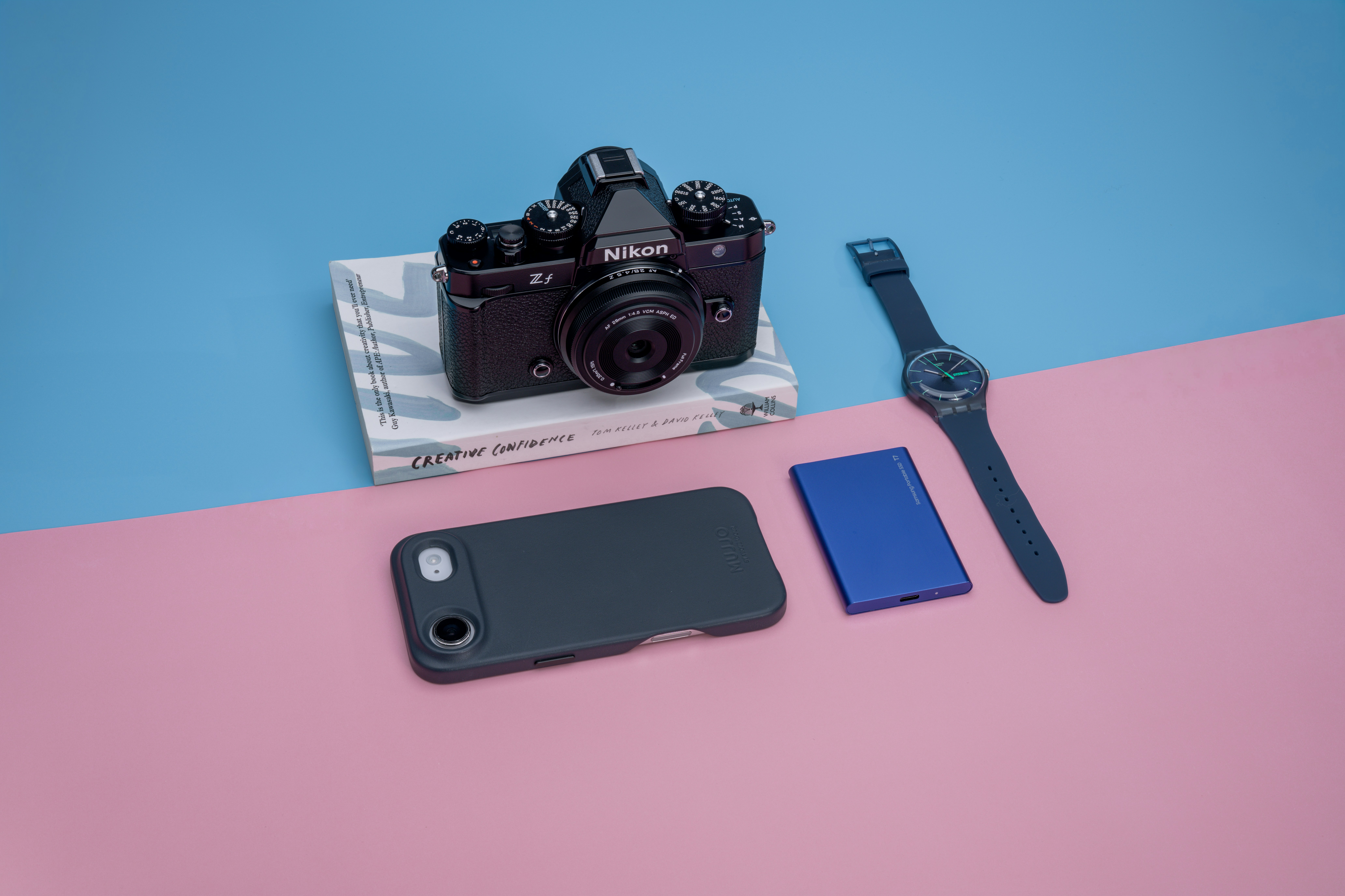Compact Moments: A Nikon Z9 and Everyday Essentials on a Color Blocked Workspace