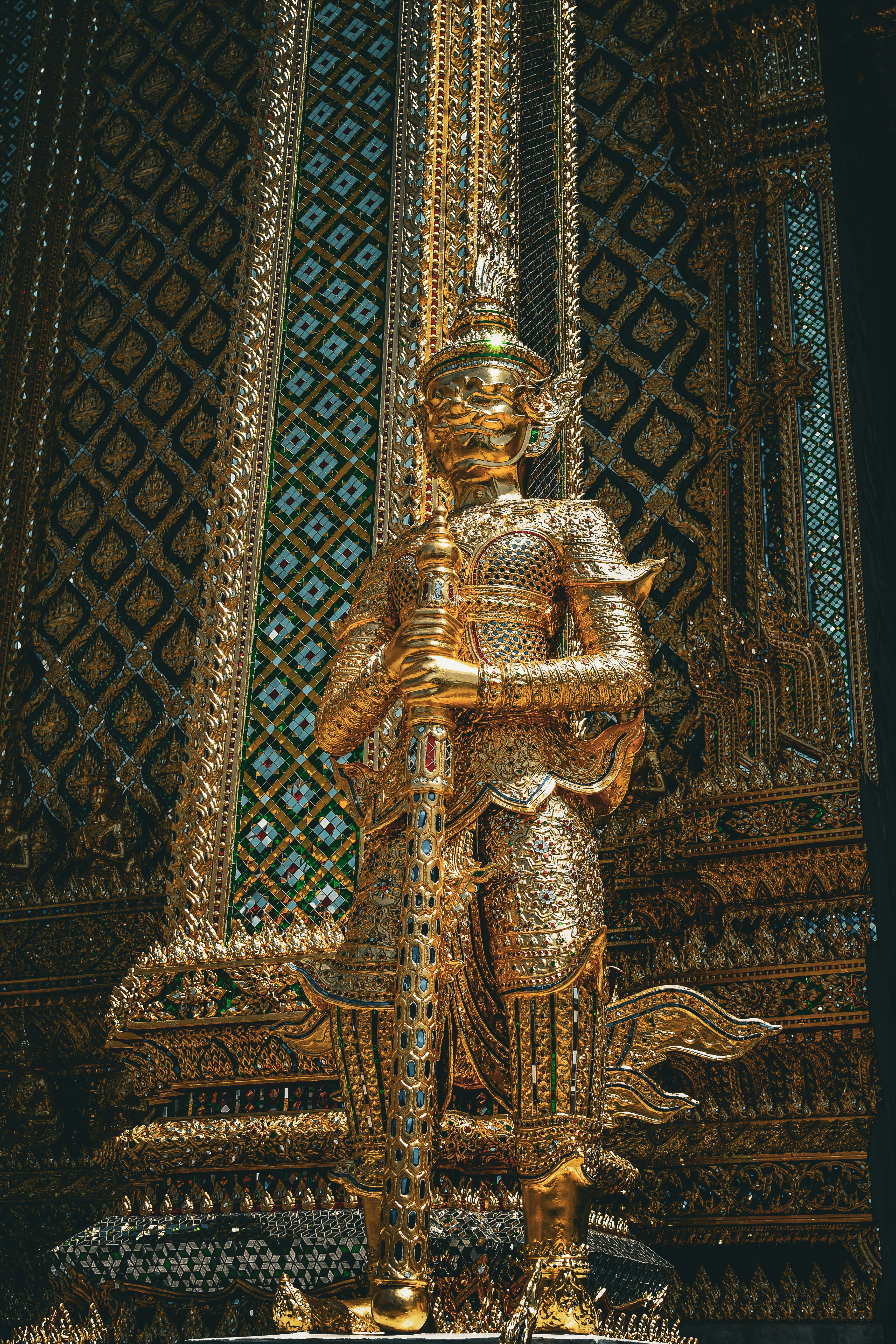 Golden Sentinel: An Ornate Guardian Standing Amid Mosaic Glory