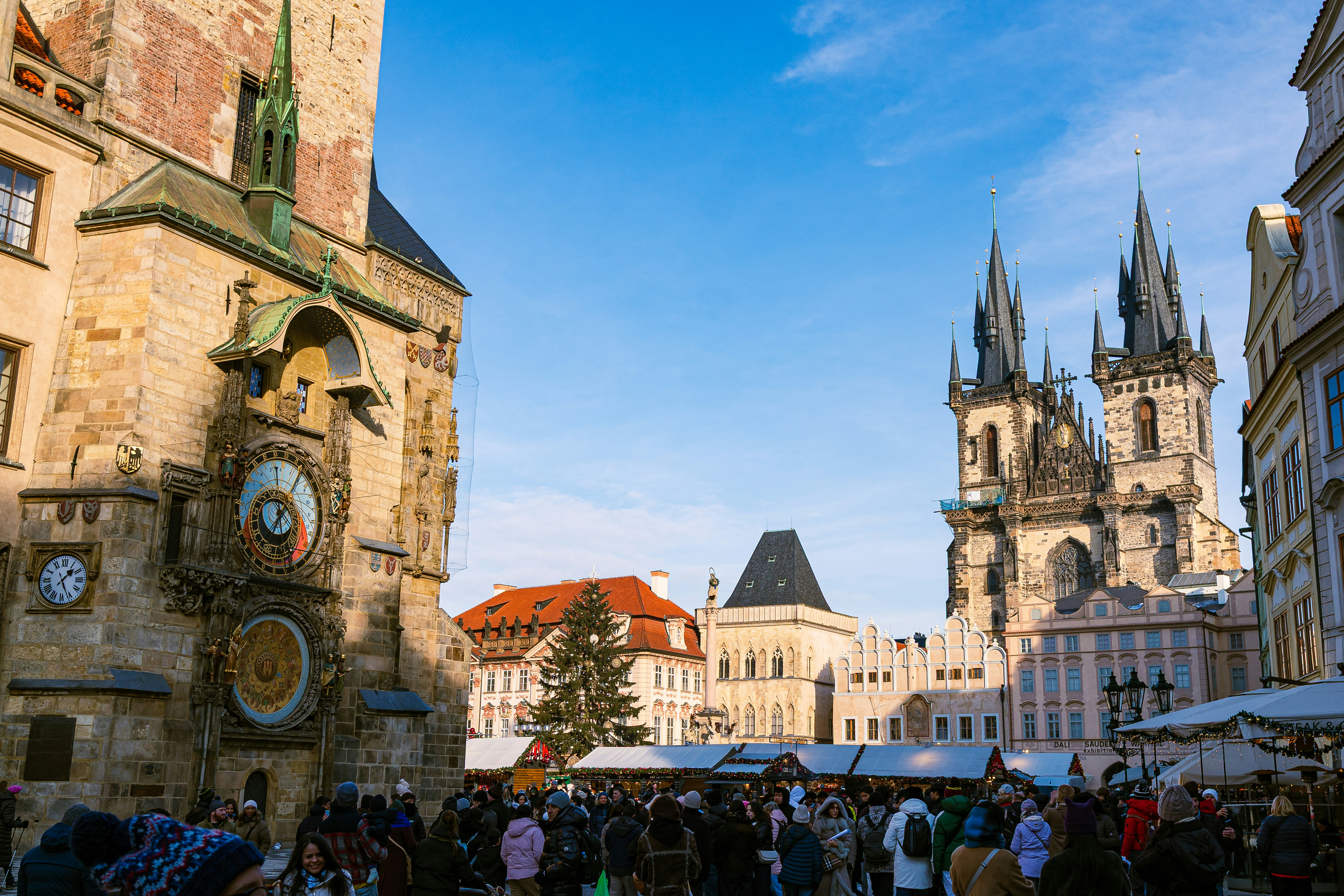 Crowd Beneath Clocktower and Gothic Spires in a Historic Square