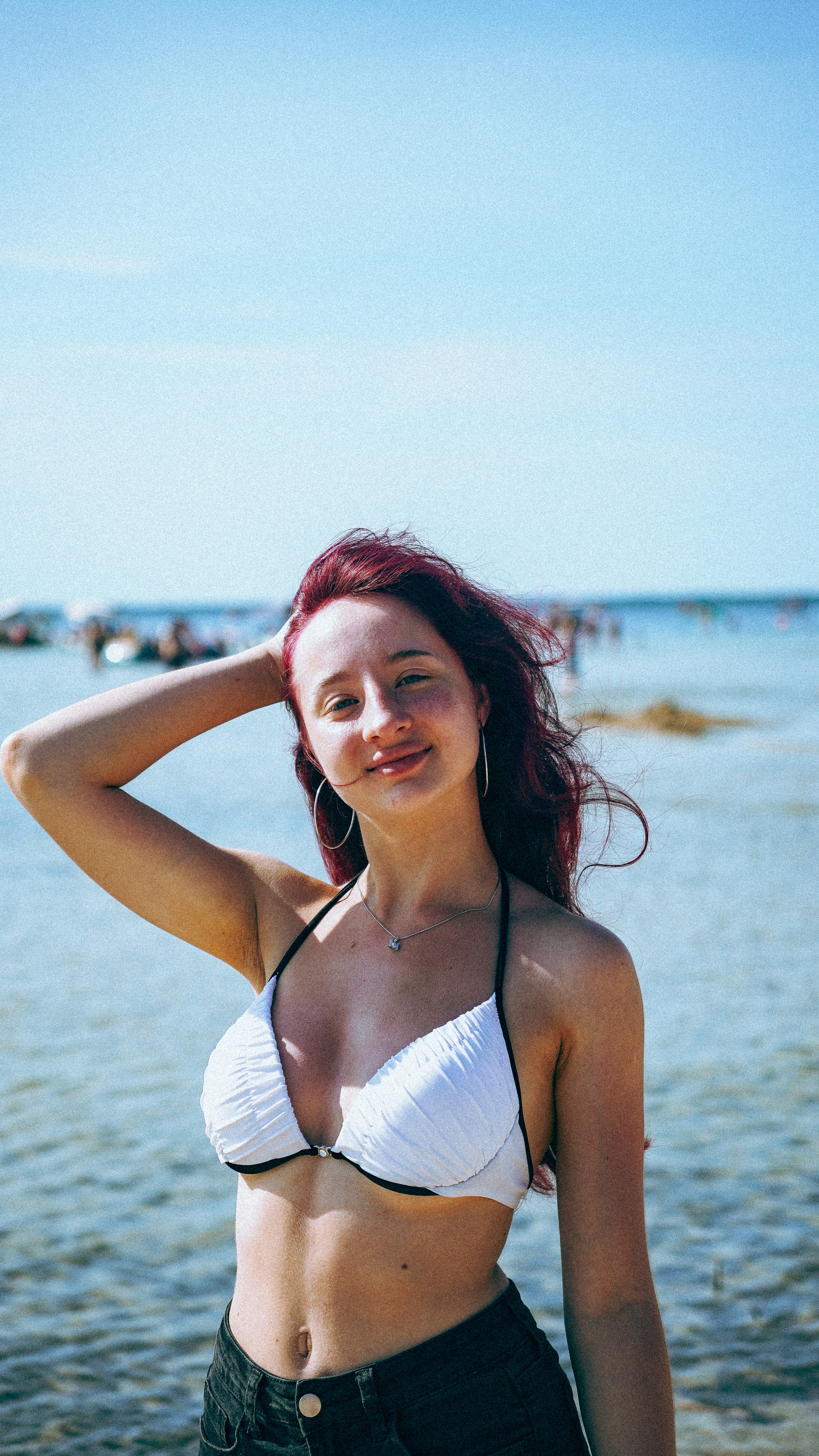 Sunlit Confidence: A Beach Portrait in White