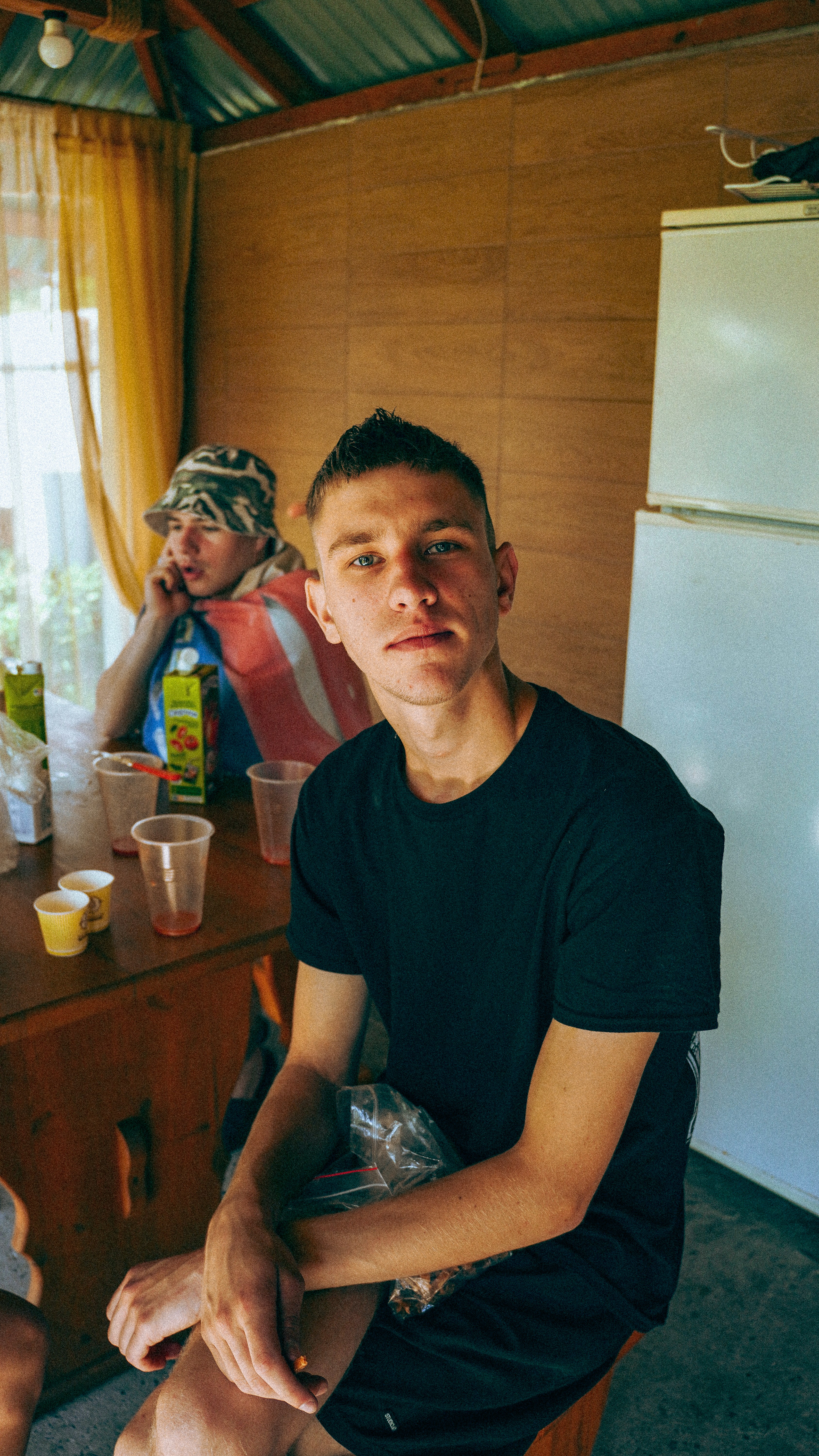 Youthful Confidence in a Sunlit Kitchen Moment