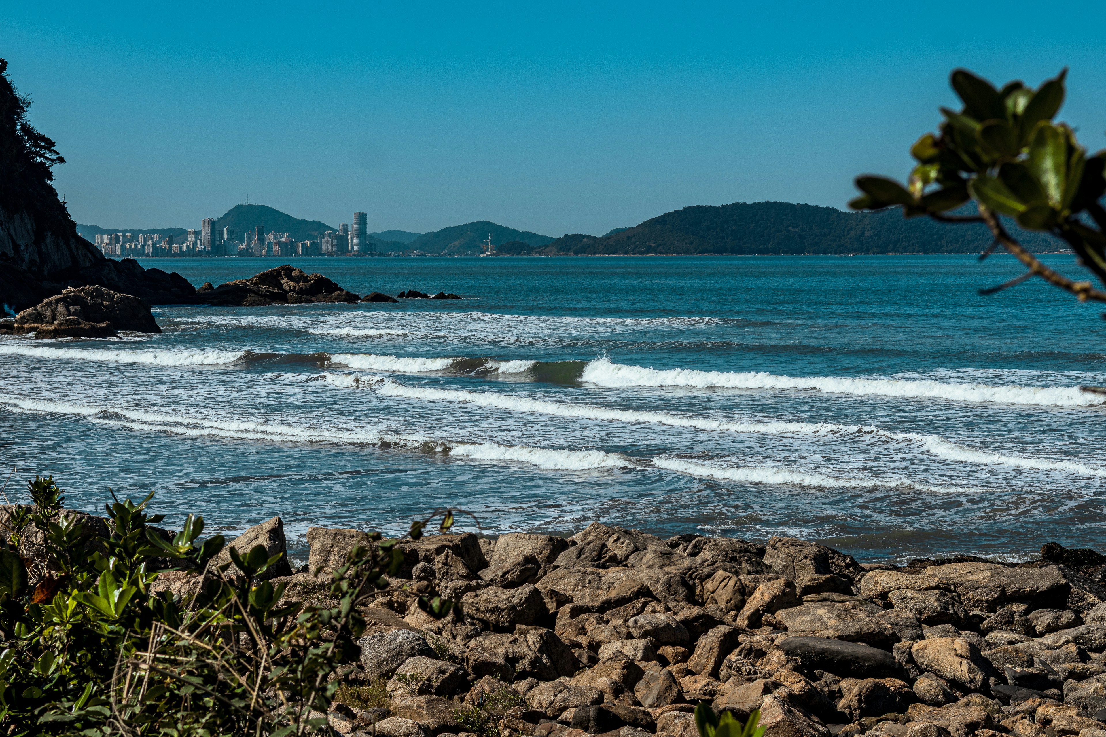 Coastal Ridge: Waves, Rocks, and Distant Skyline