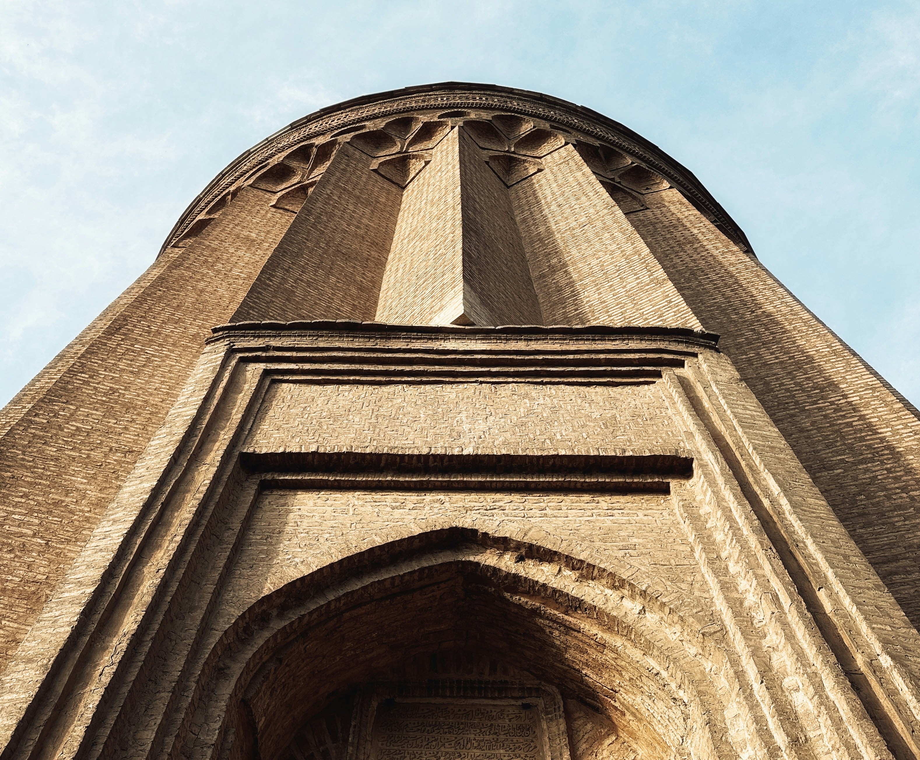 A Focused Ascent: Close‑up of a Gothic Brick Tower Reaching Toward the Sky