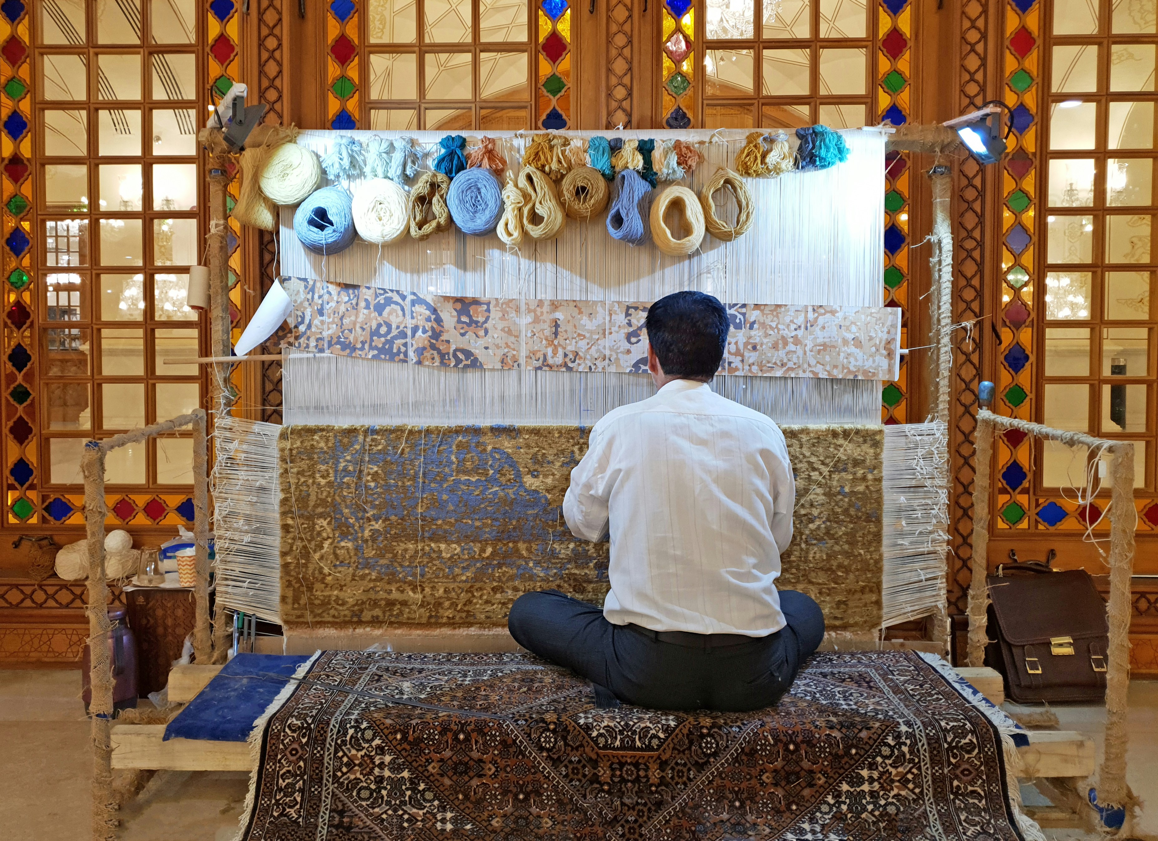 Weaver at the Loom: Crafting Gold in a Sunlit Studio