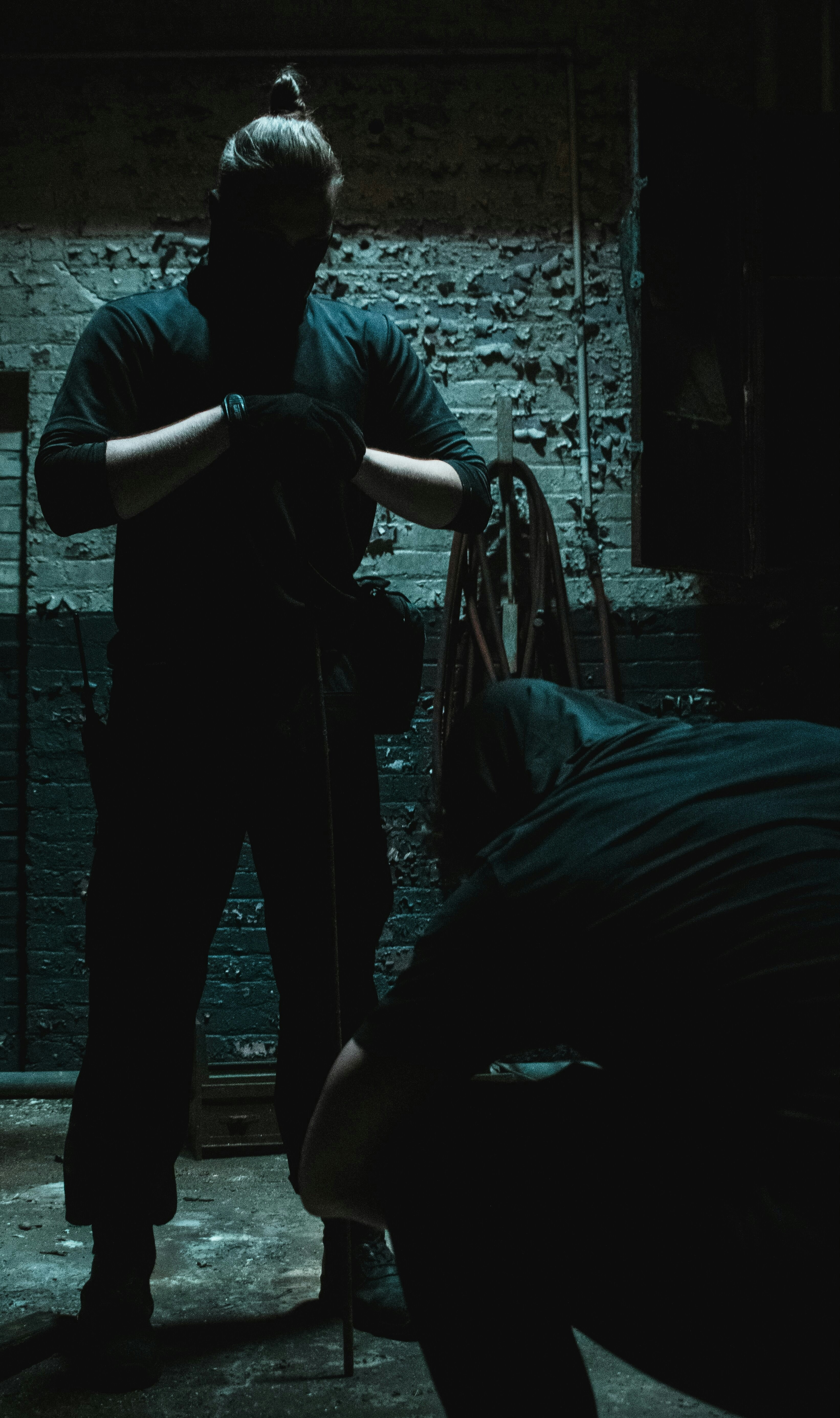 Shadowed Prep: A Gripping Moment in a Dim Workshop