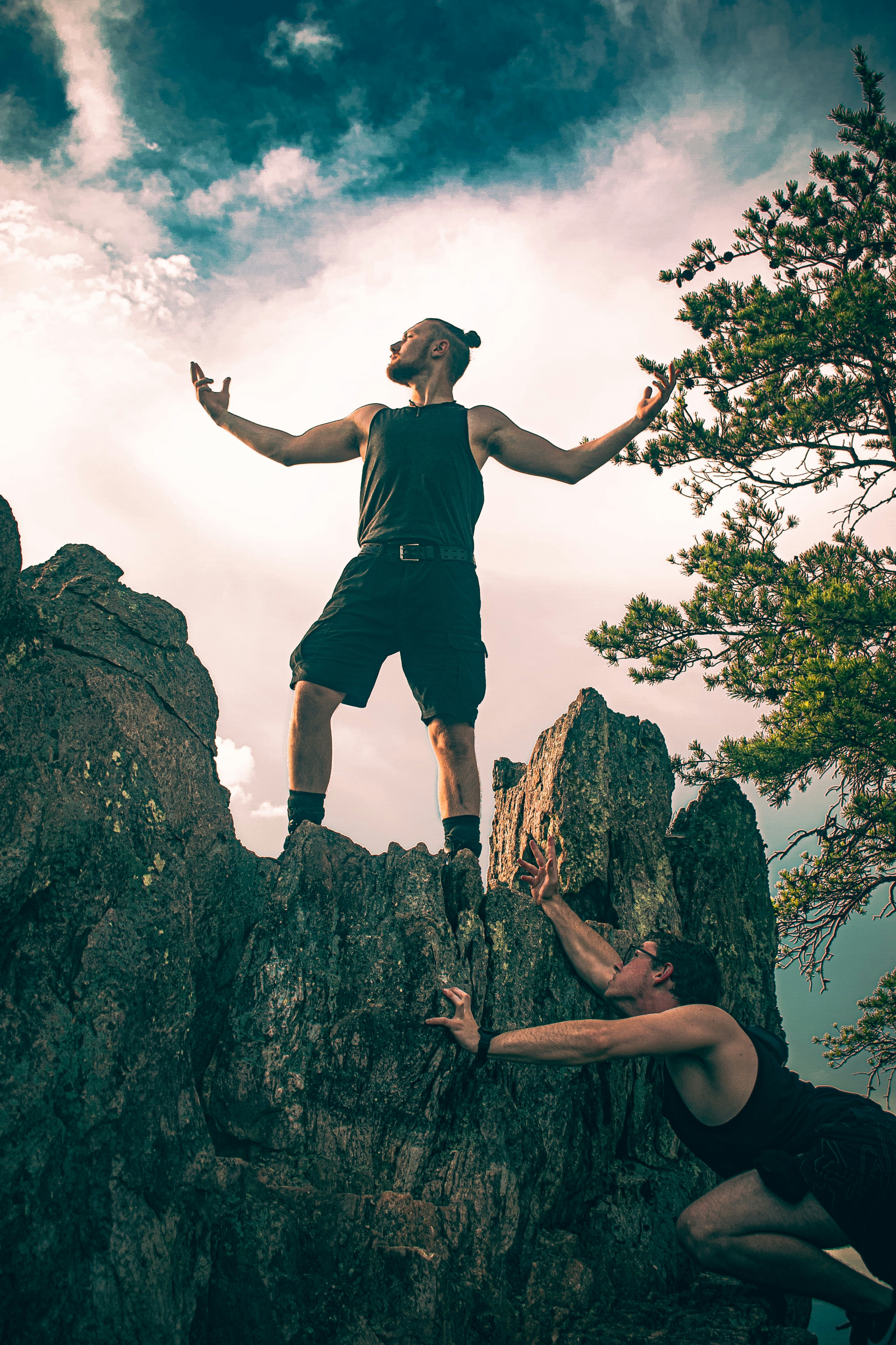 Top of the Peak: Man Standing Between Sky and Stone