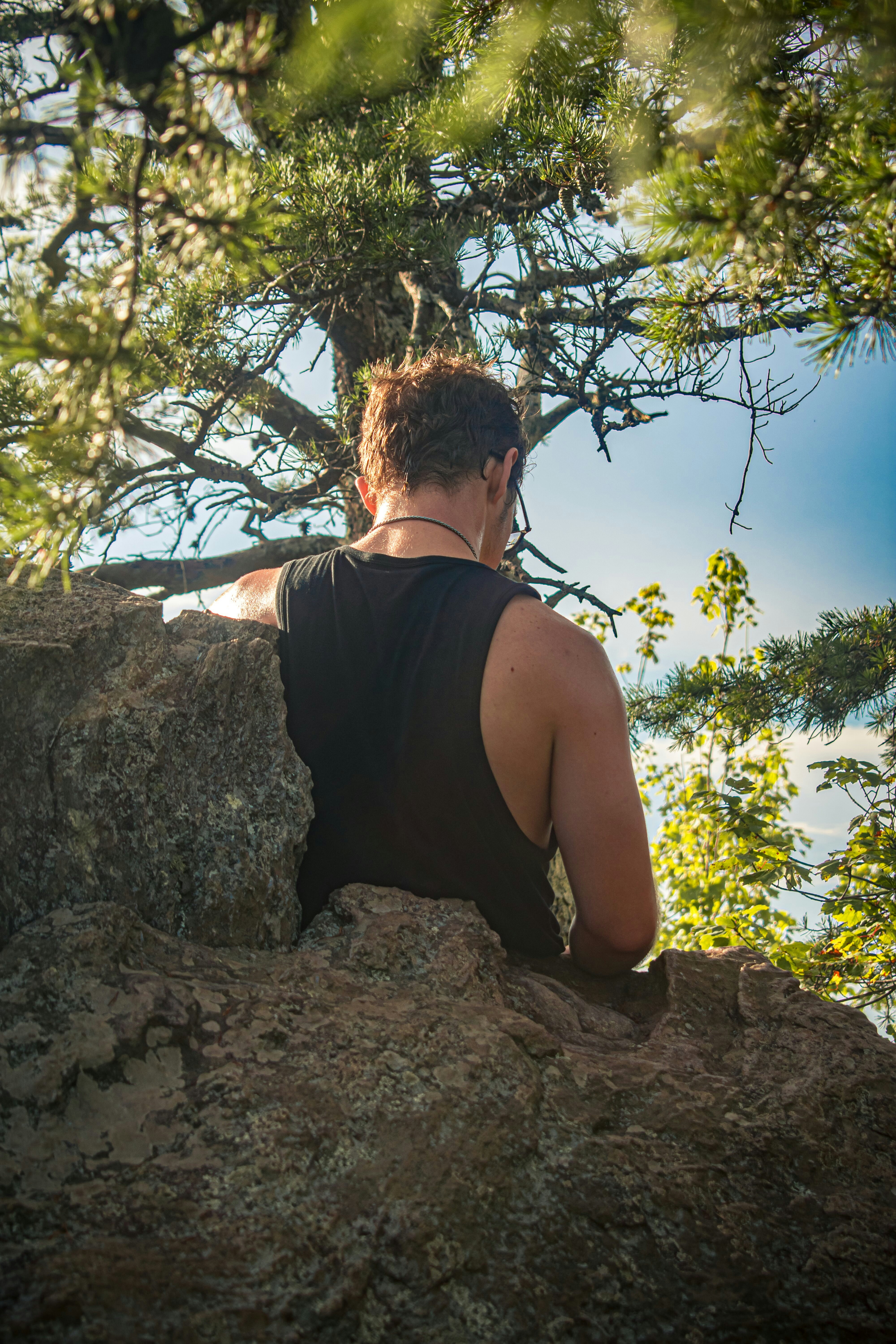 Cliffside Climber: A Portrait Amid Stone and Sunlight