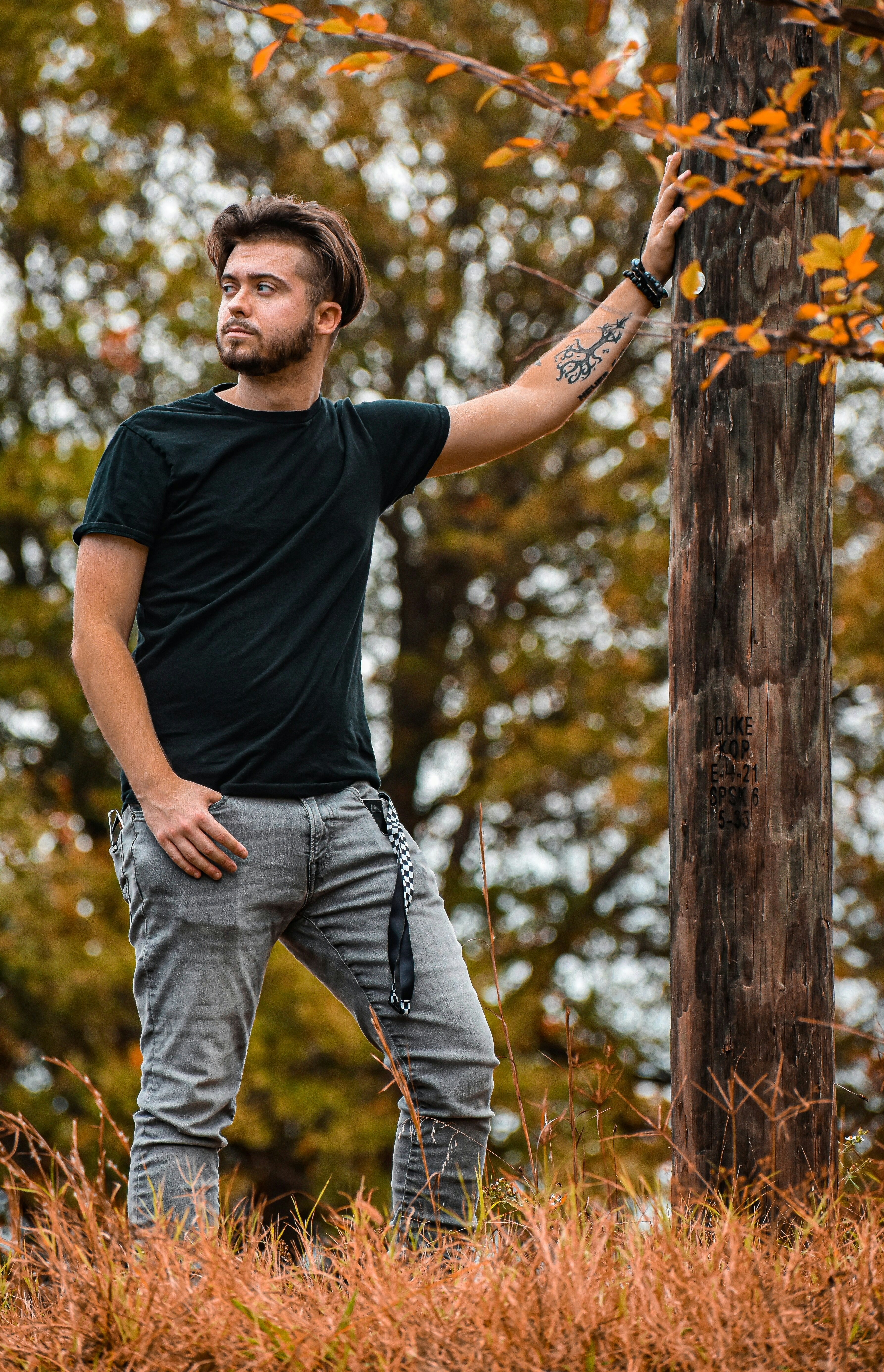 Outstretched Confidence Beneath Autumn Canopy