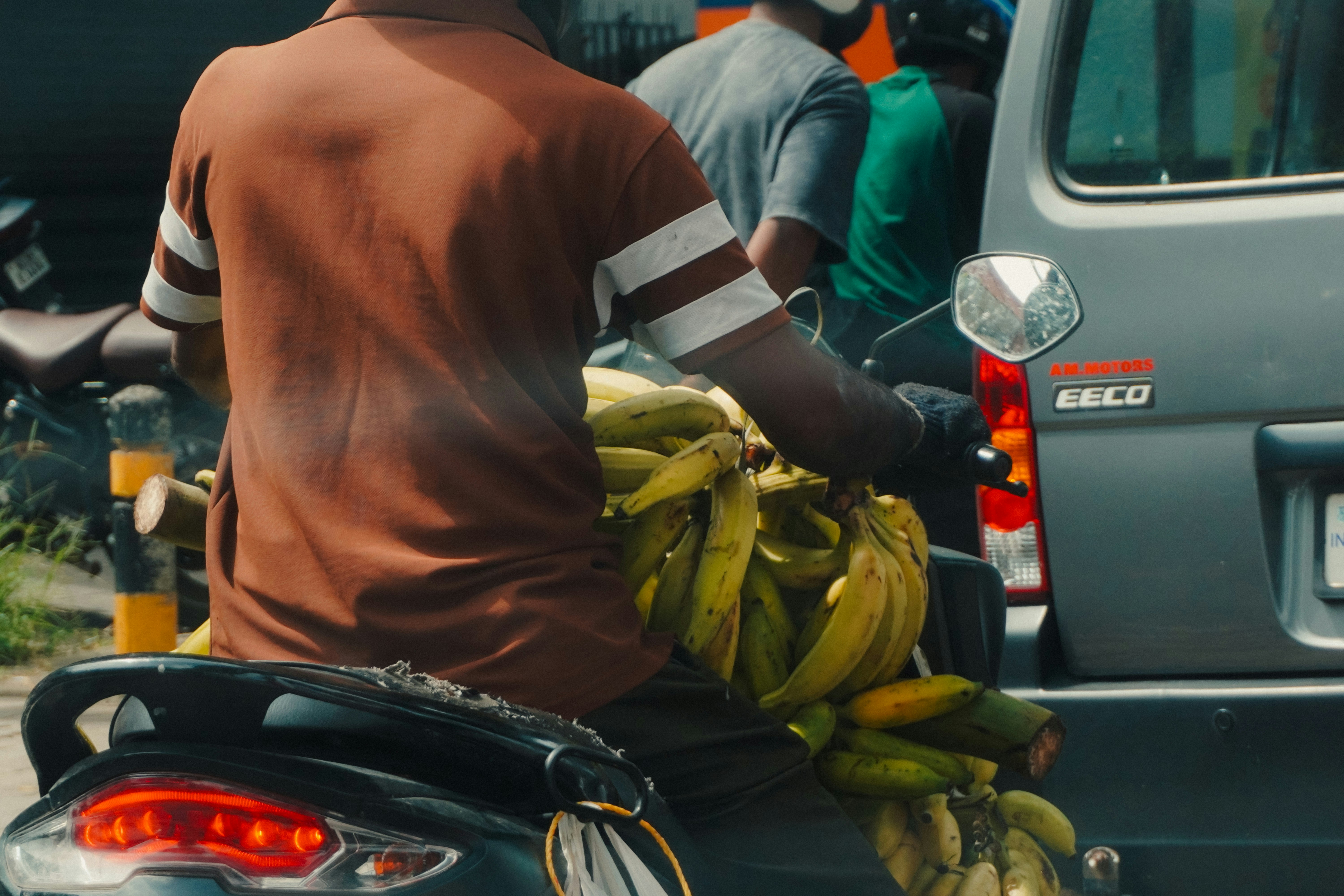 Banana Vendor in Transit: A Rider’s Rest Among Traffic