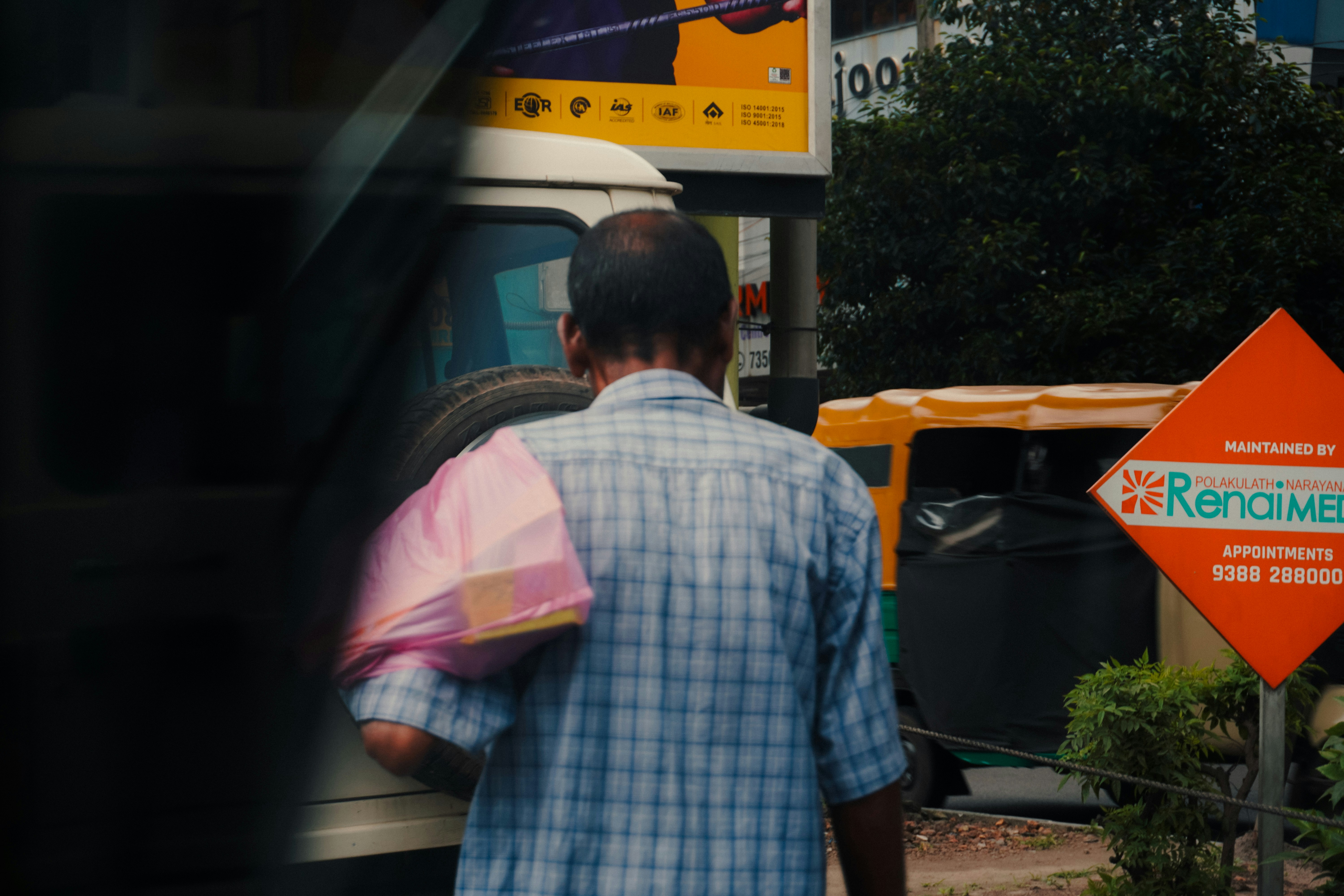 A Busy Street Moment: Stranger in Shadowed Frame