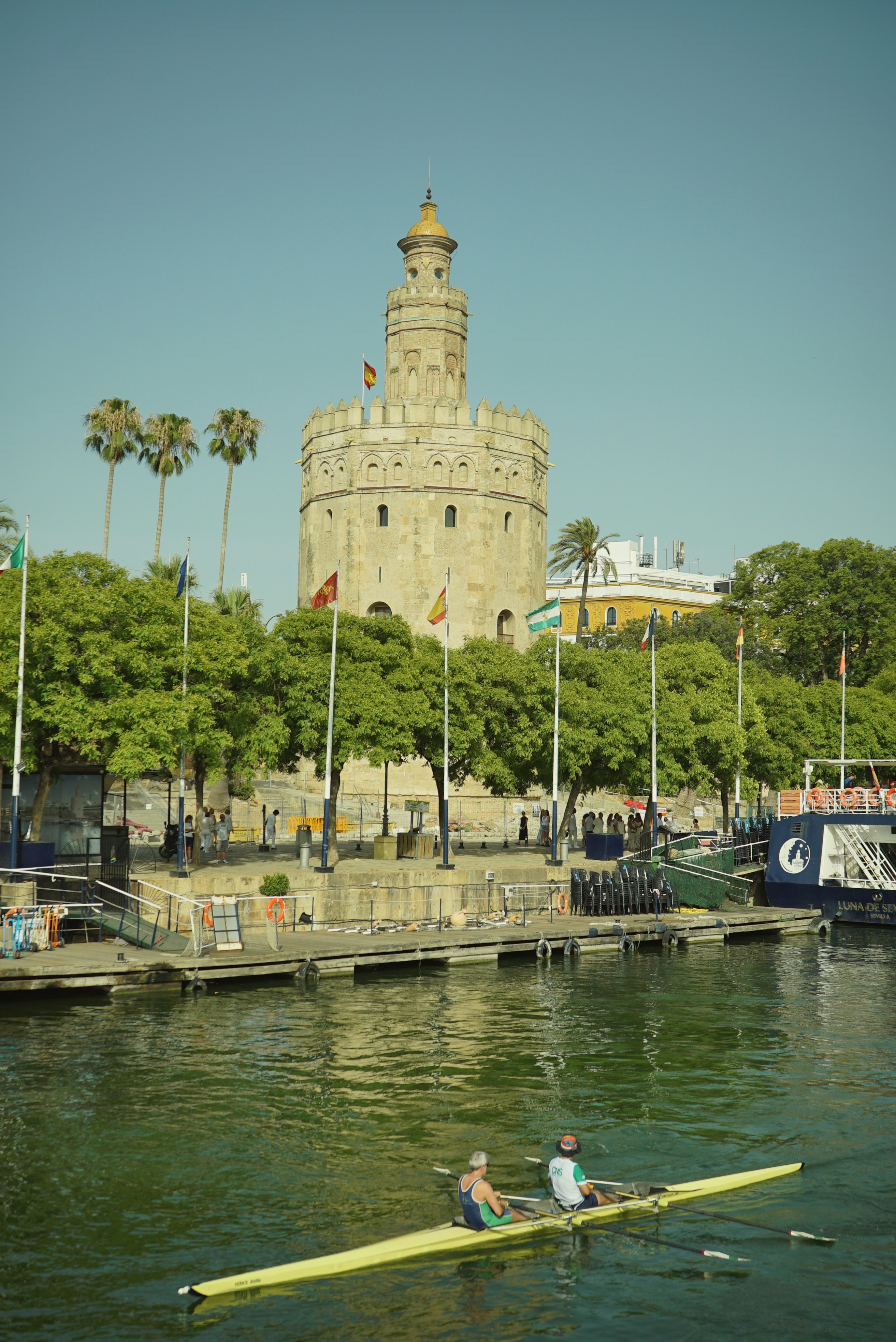 Tower at the Waterfront: Moonlit Stone and Serene Rowing
