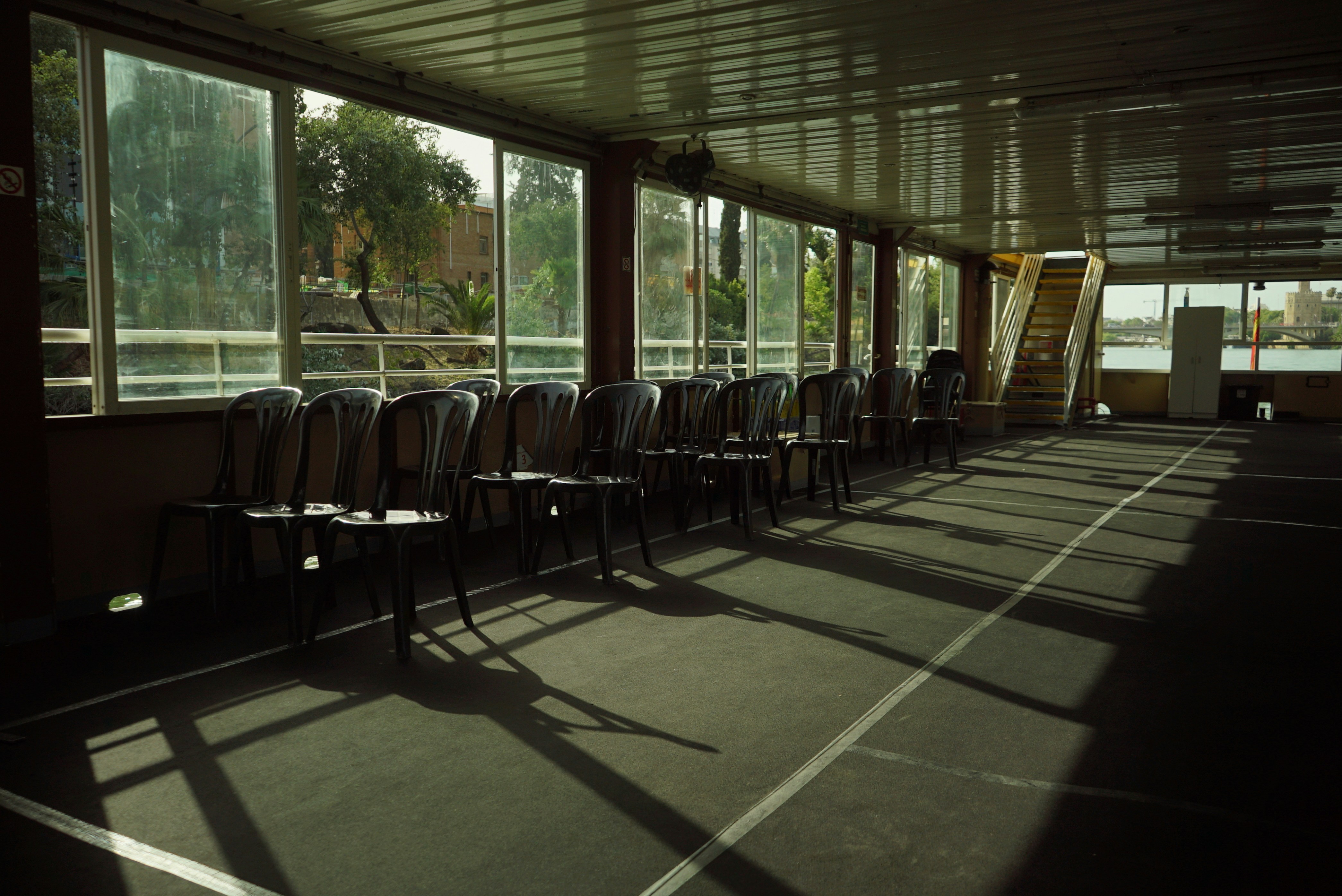 Abandoned gymnasium: rows of empty chairs under dim light