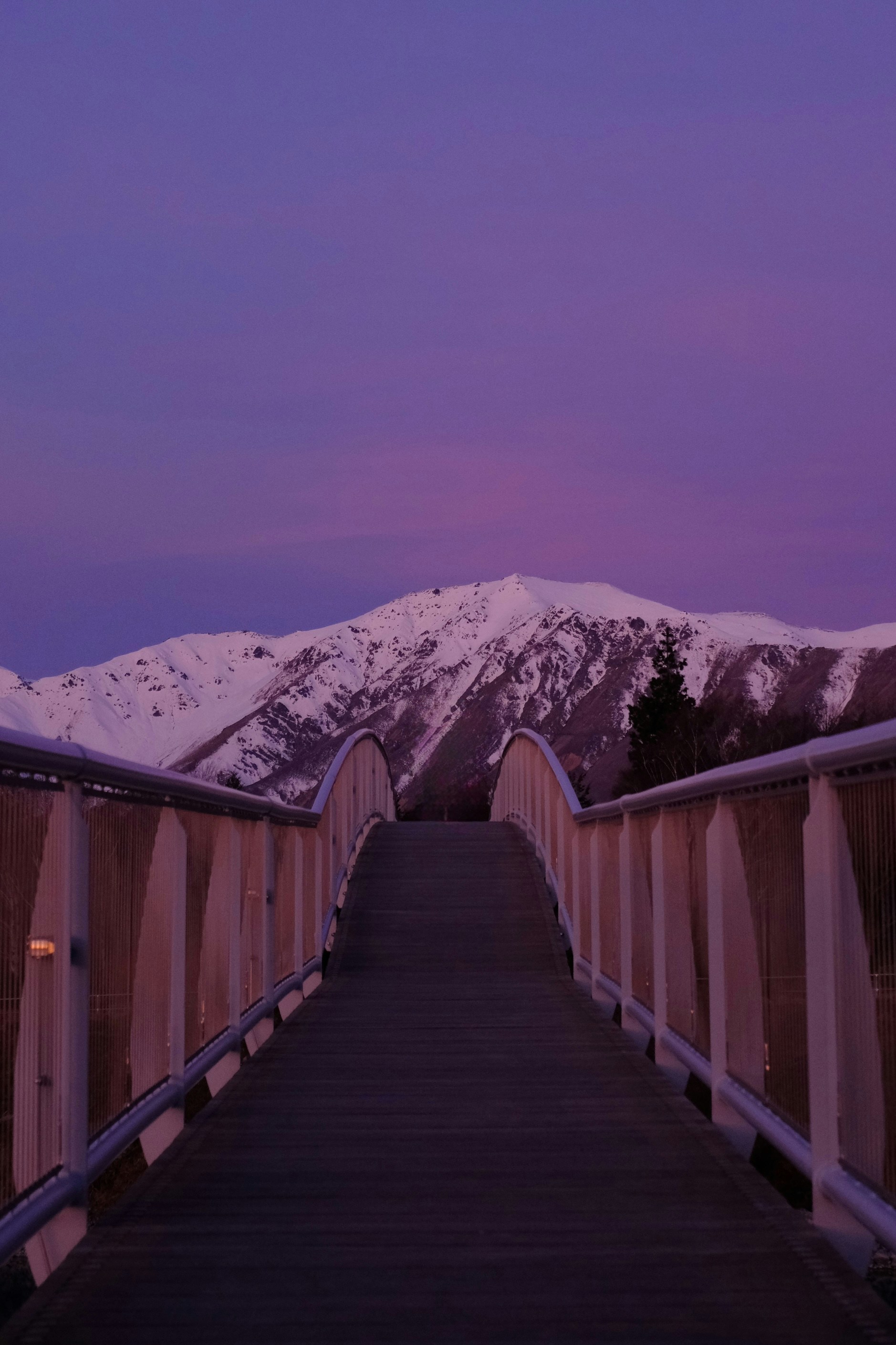 Bridge to the Snow-Kissed Ridge at Twilight