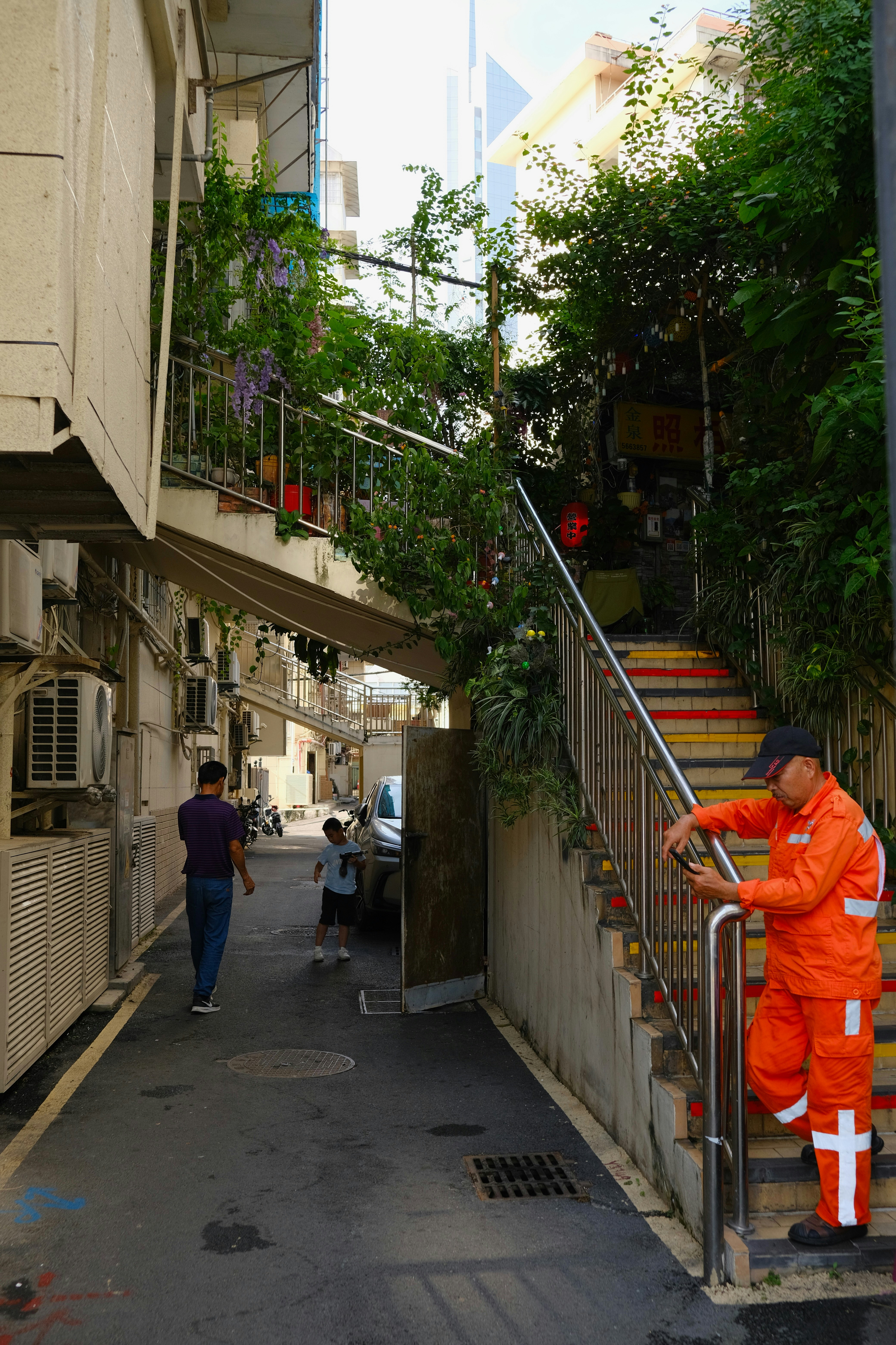 Rural Urban Staircase Escort: A Worker in Orange at a Yan Street Corner