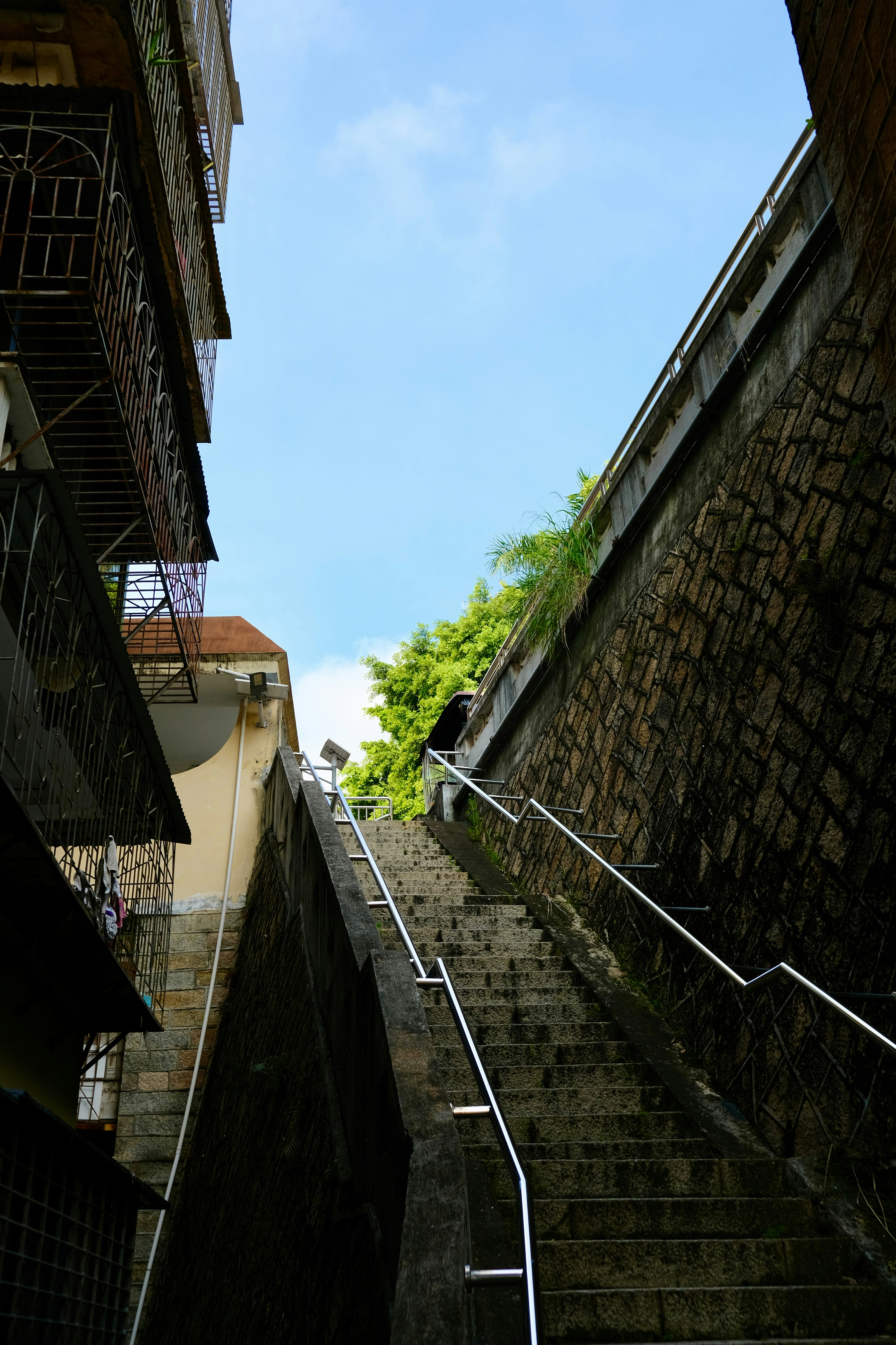 Urban Ascent: Stairs of Concrete Echoes toward the Sunlit Sky
