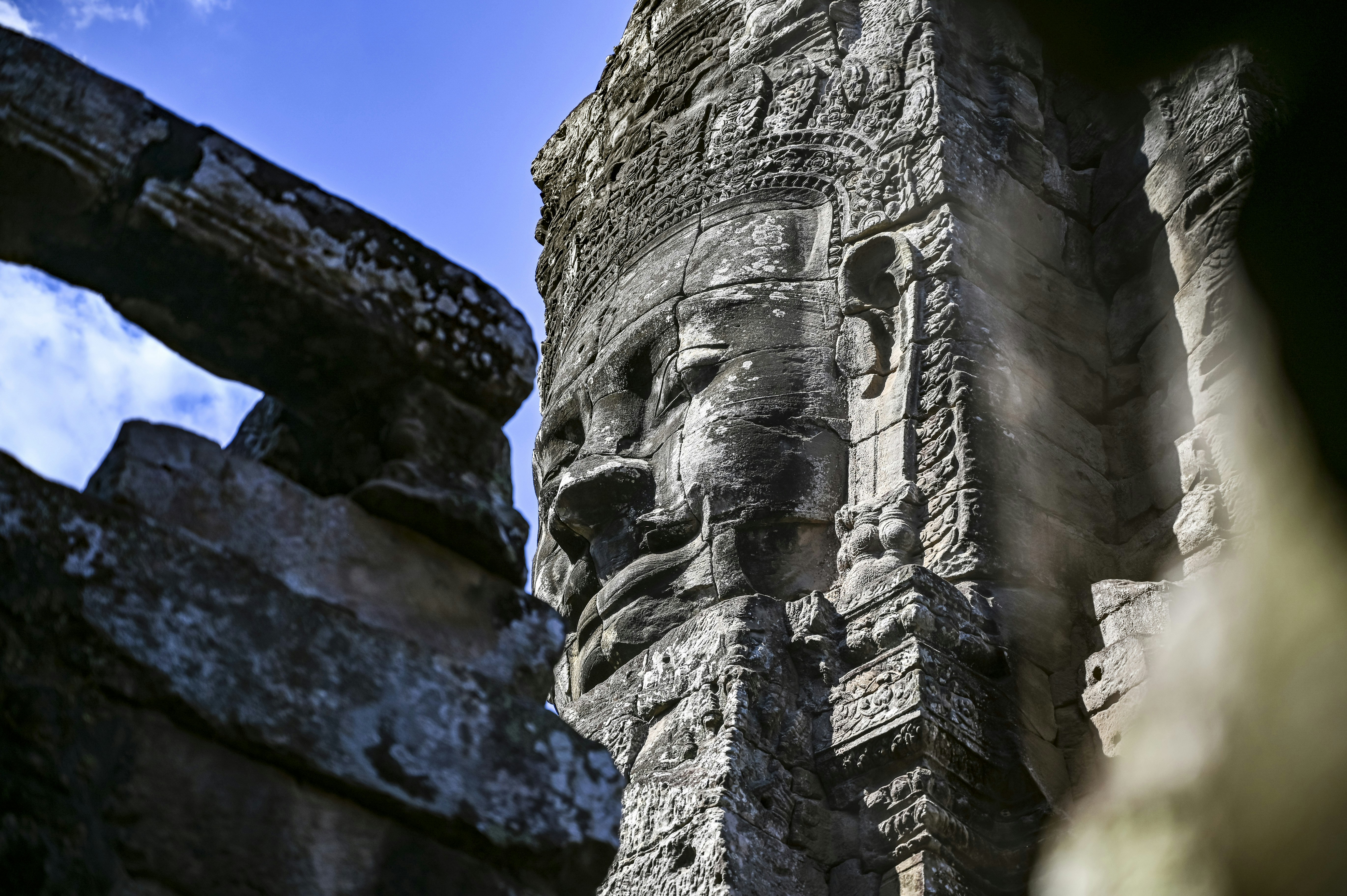 Stone Guardian: A Carved Face Reaches Toward the Sky