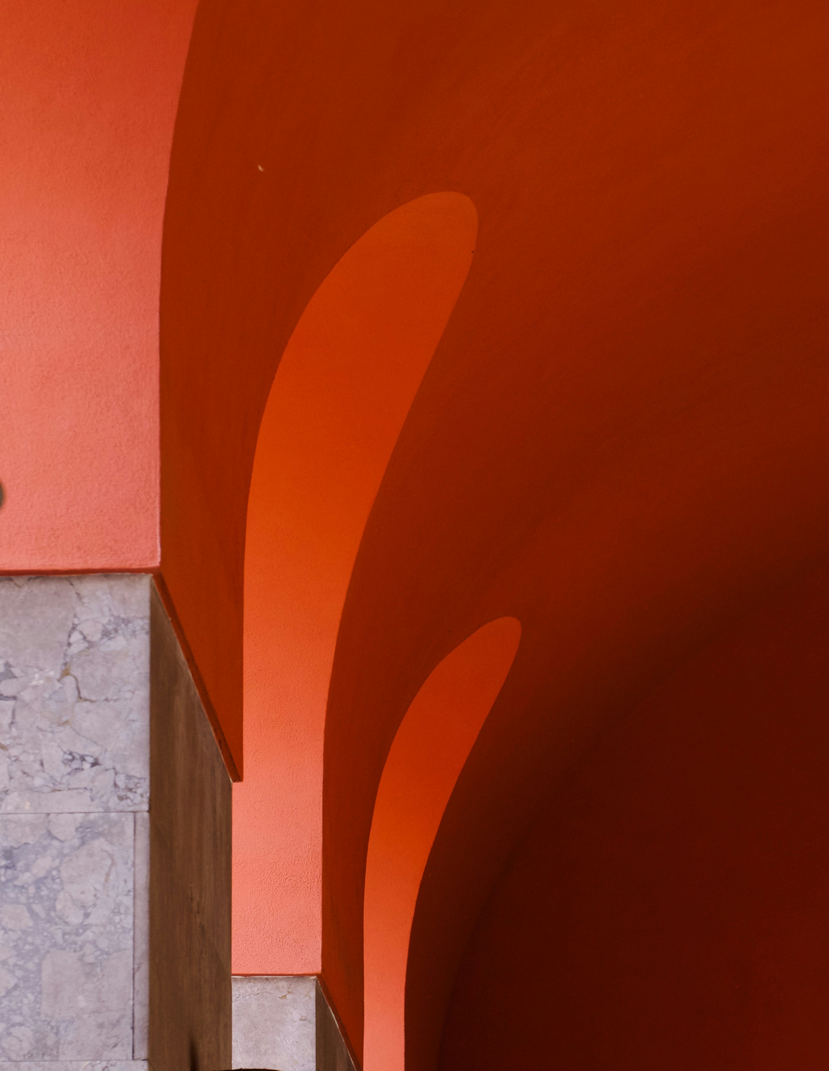 Archway Echoes: A Bold Slice of Orange Concrete