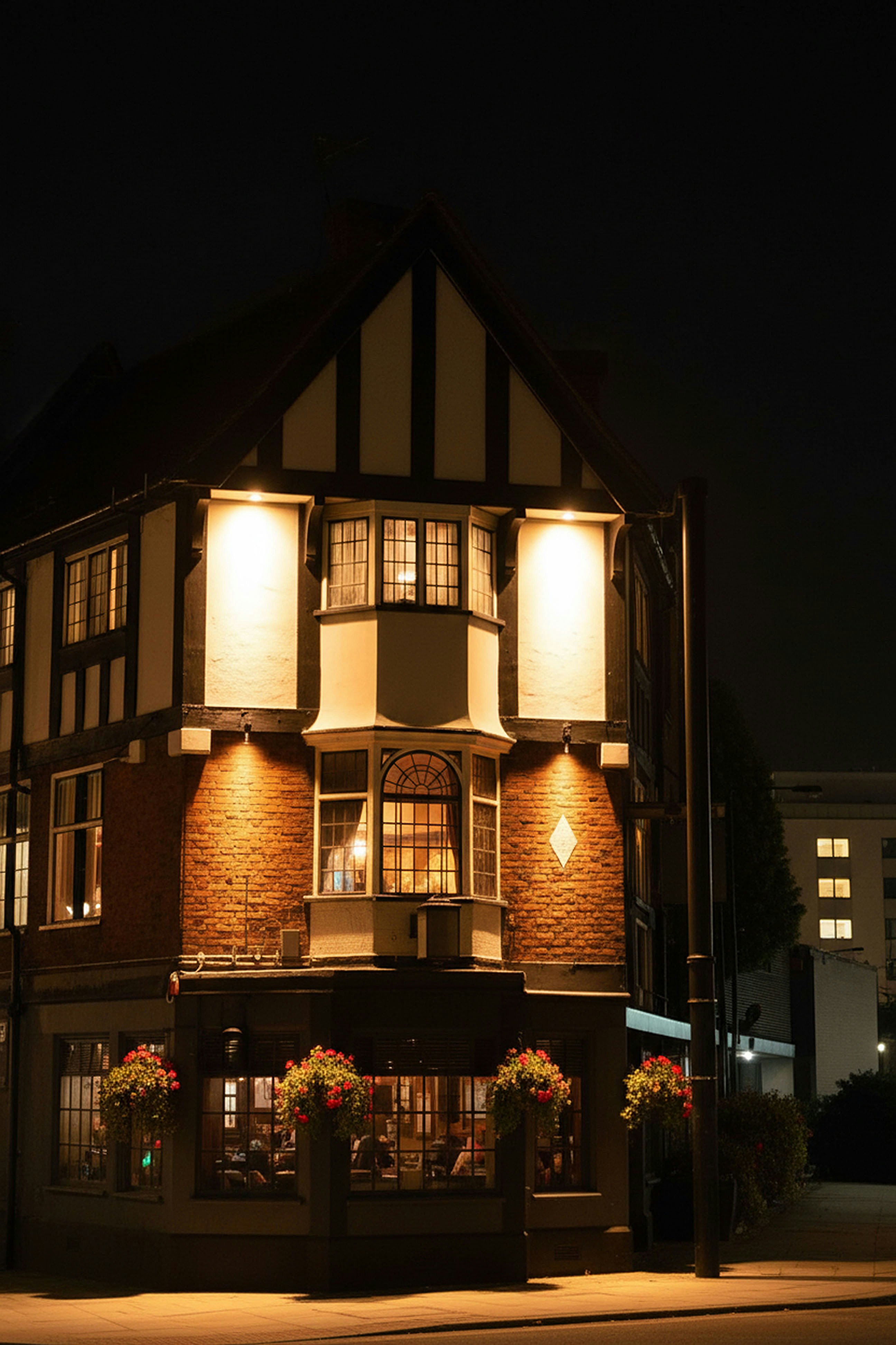 Gas-lit Charm: A Tudor-inspired Corner Café Illuminated at Night