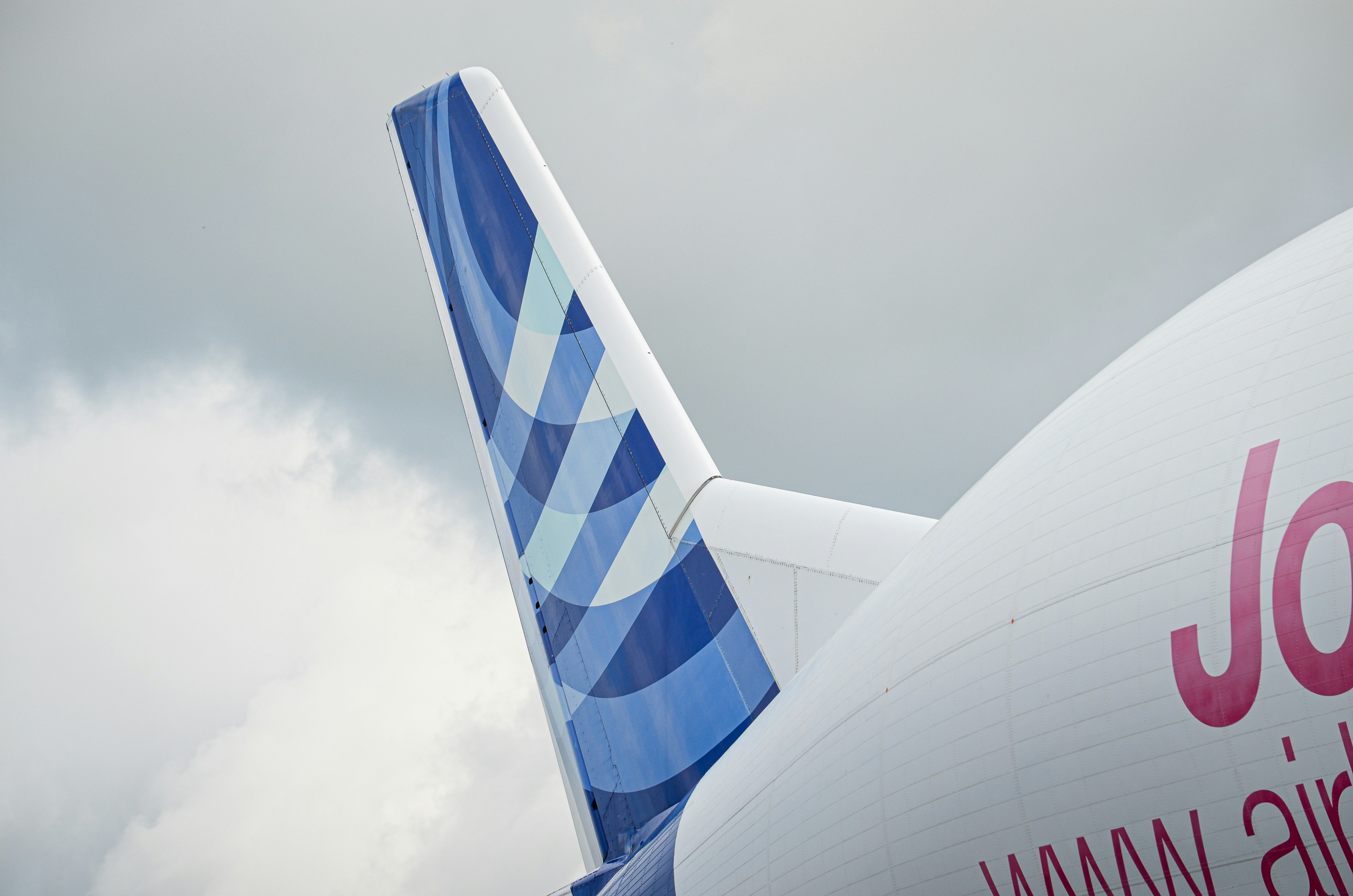 Blue-tinted aircraft tail and fuselage curve at takeoff
