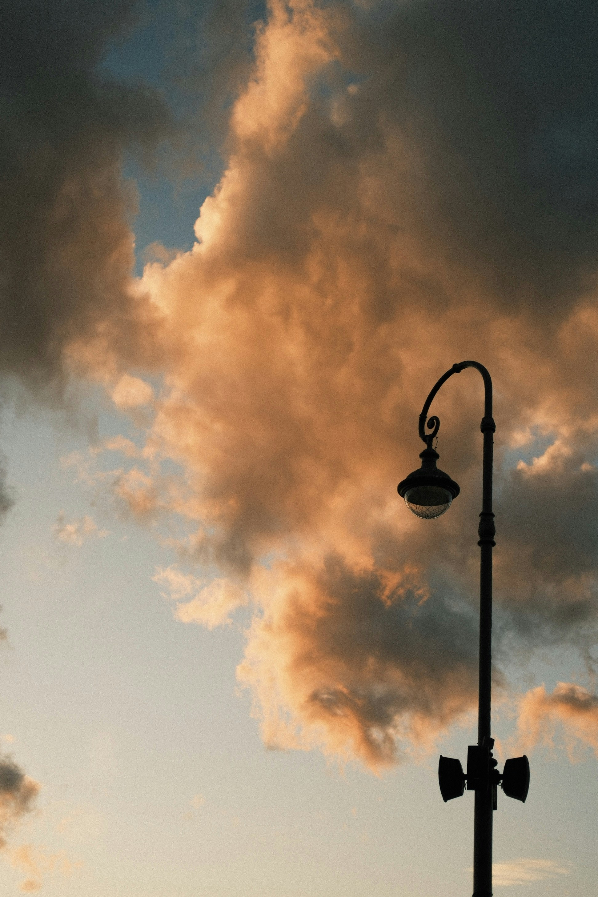 Silhouetted Streetlamp Against Sunset Quill Clouds