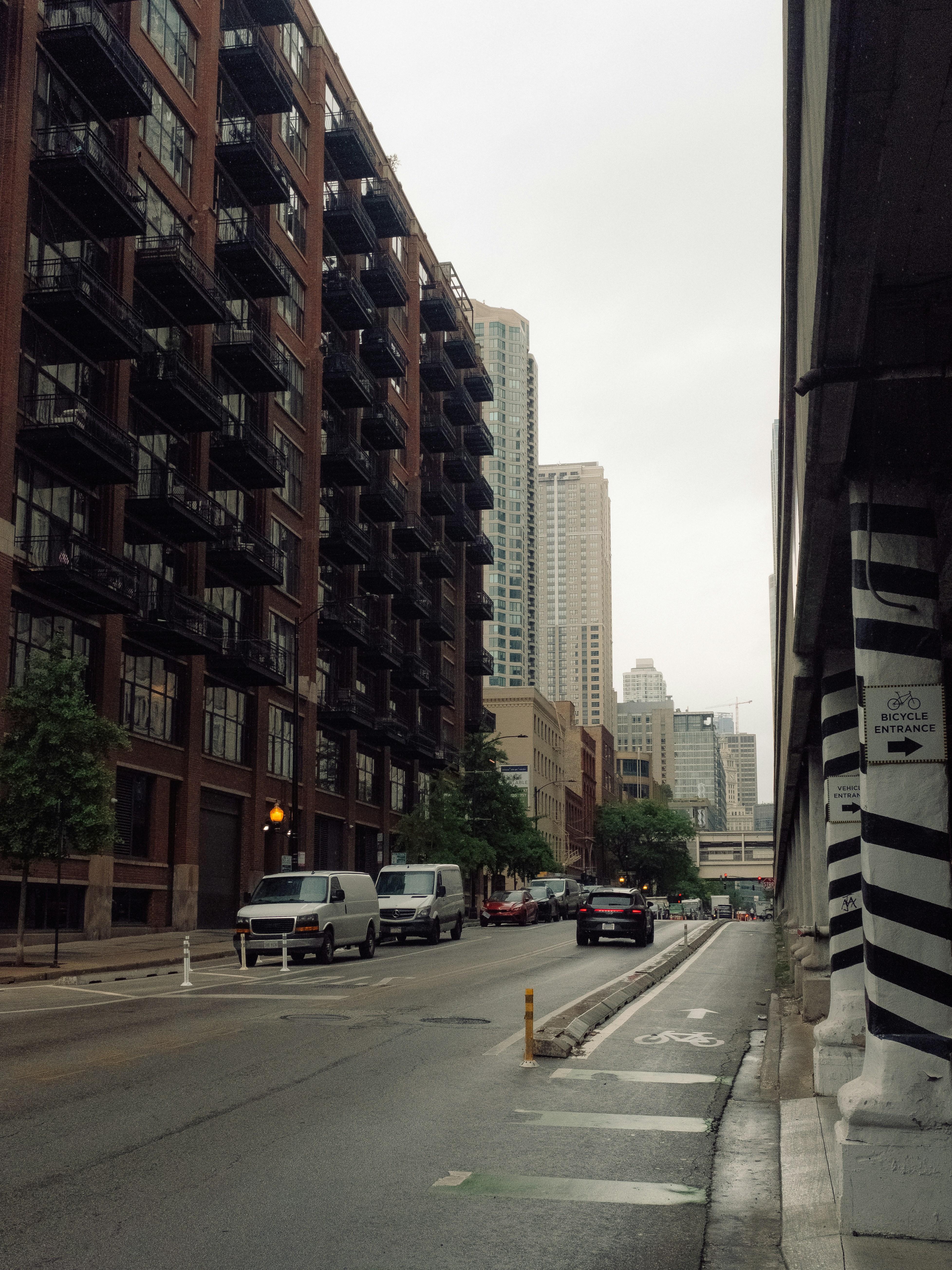 City Street Ascent: Narrow Corridor Between Brick Towers