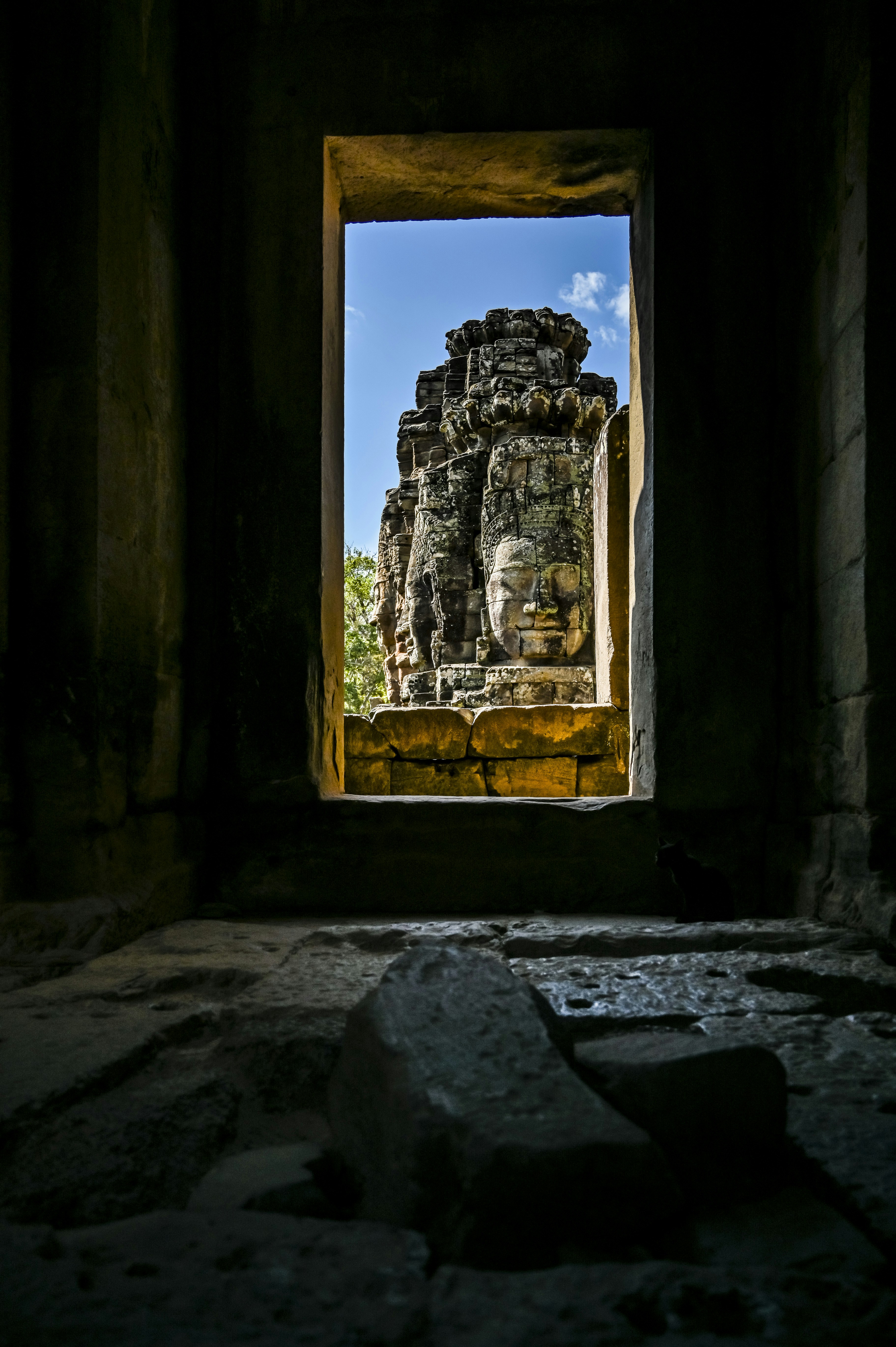 Window to the Stone Guardian: Monument Framed by a Dark Hall