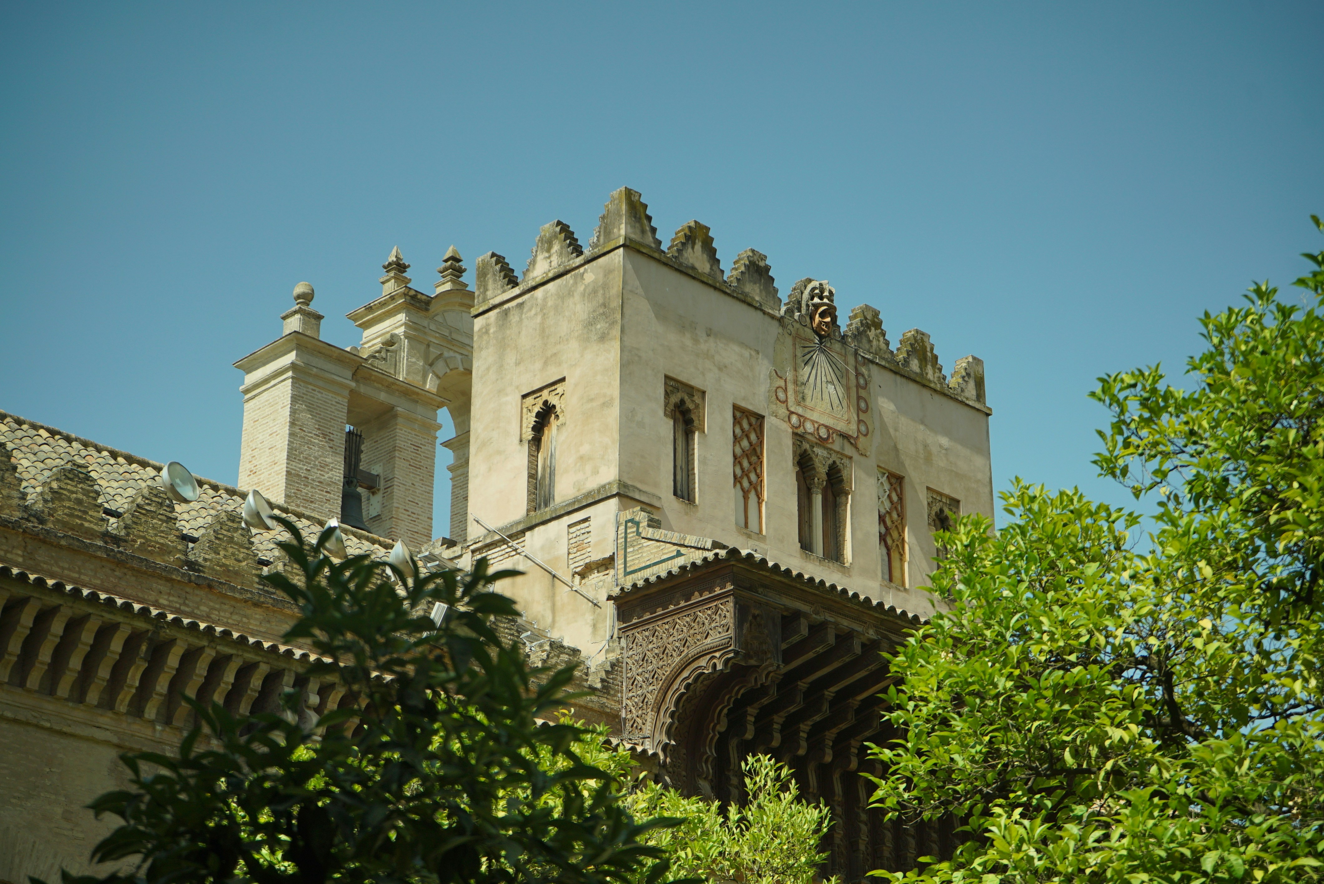 Sunlit Moorish Balcony Tower Rising Above Lush Foliage