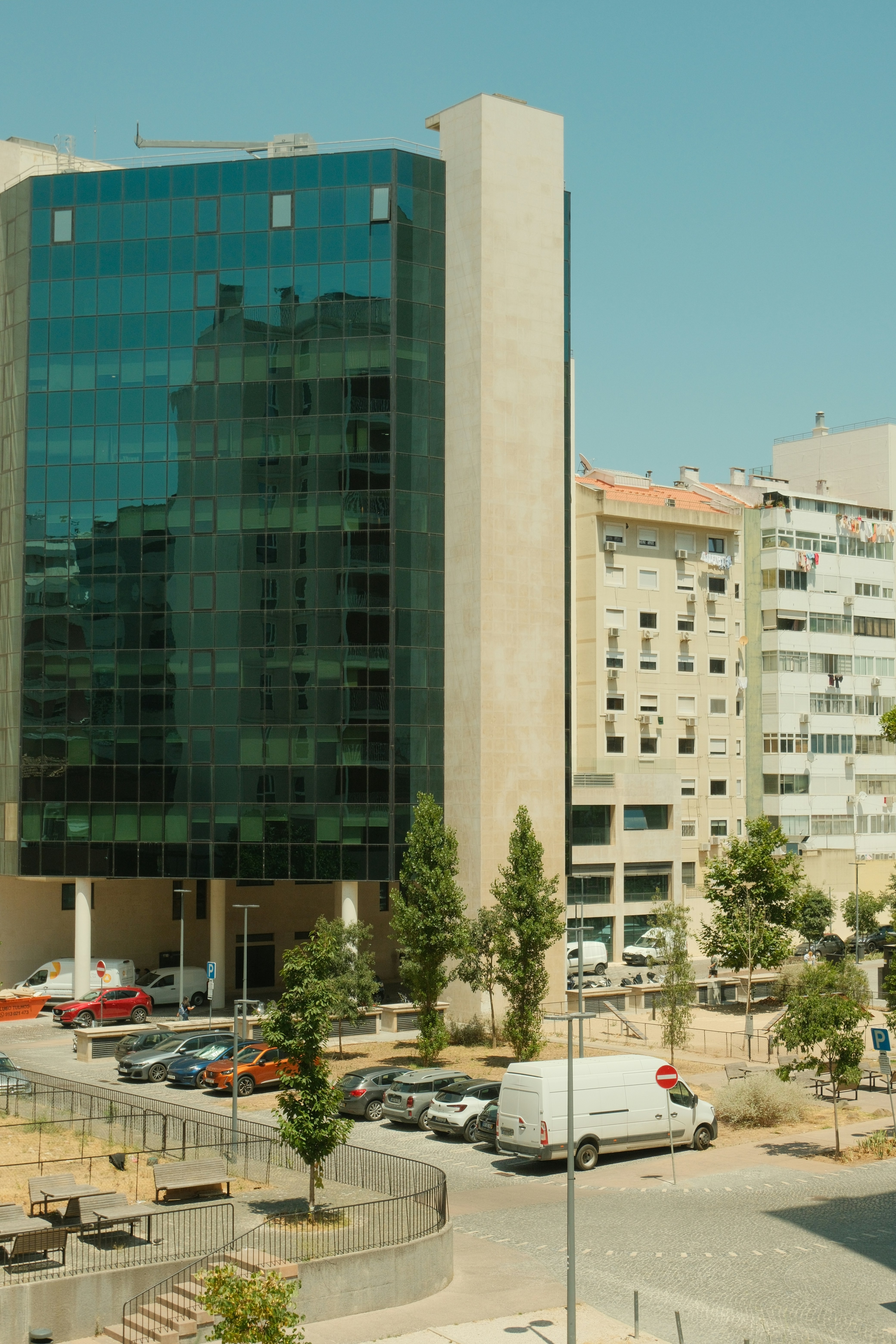 Glass Facade, Concrete Tower: Urban Office Block Reflects the Sky
