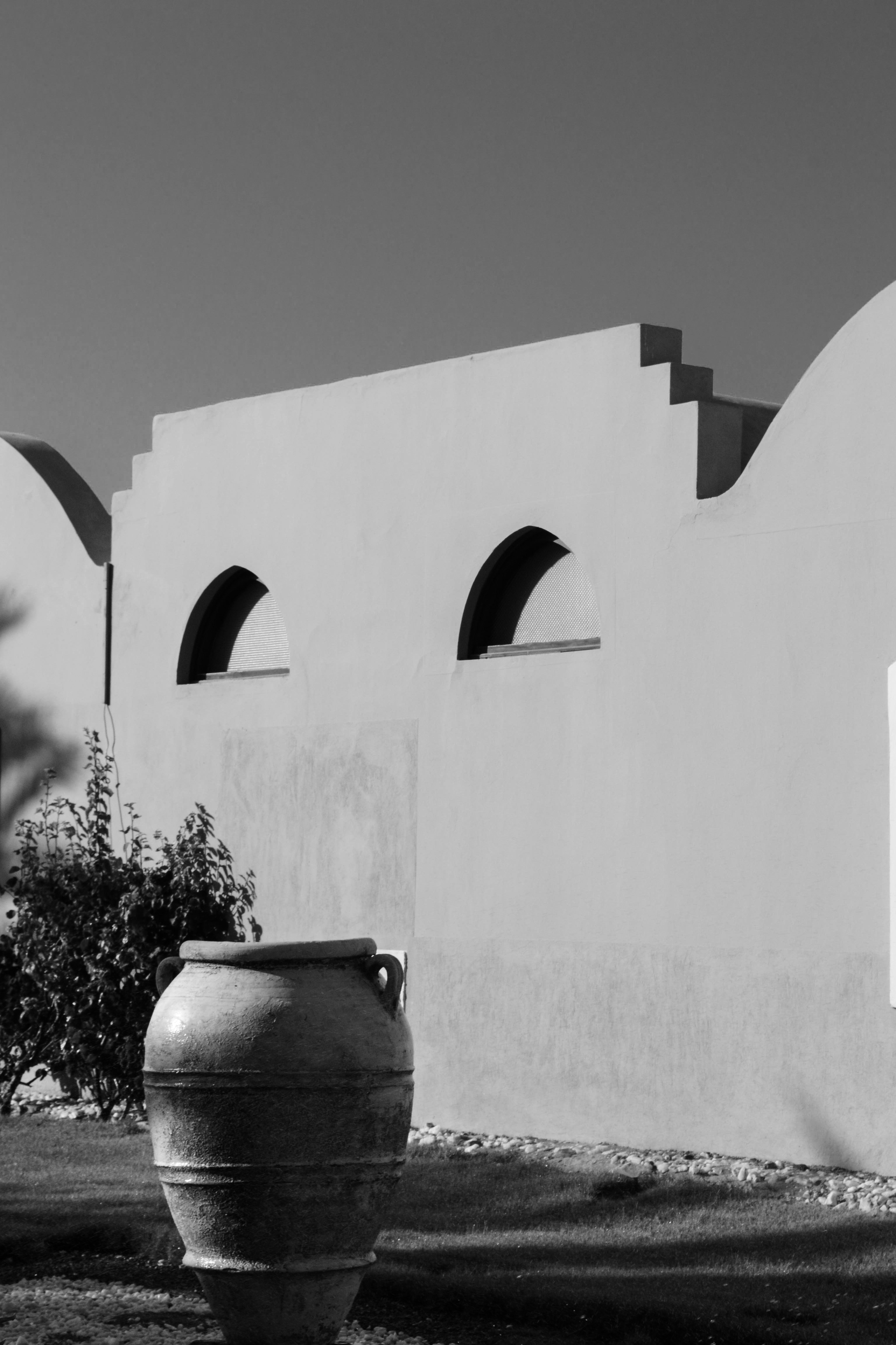 Whitewashed Architecture and Earthen Jar under Desert Sun