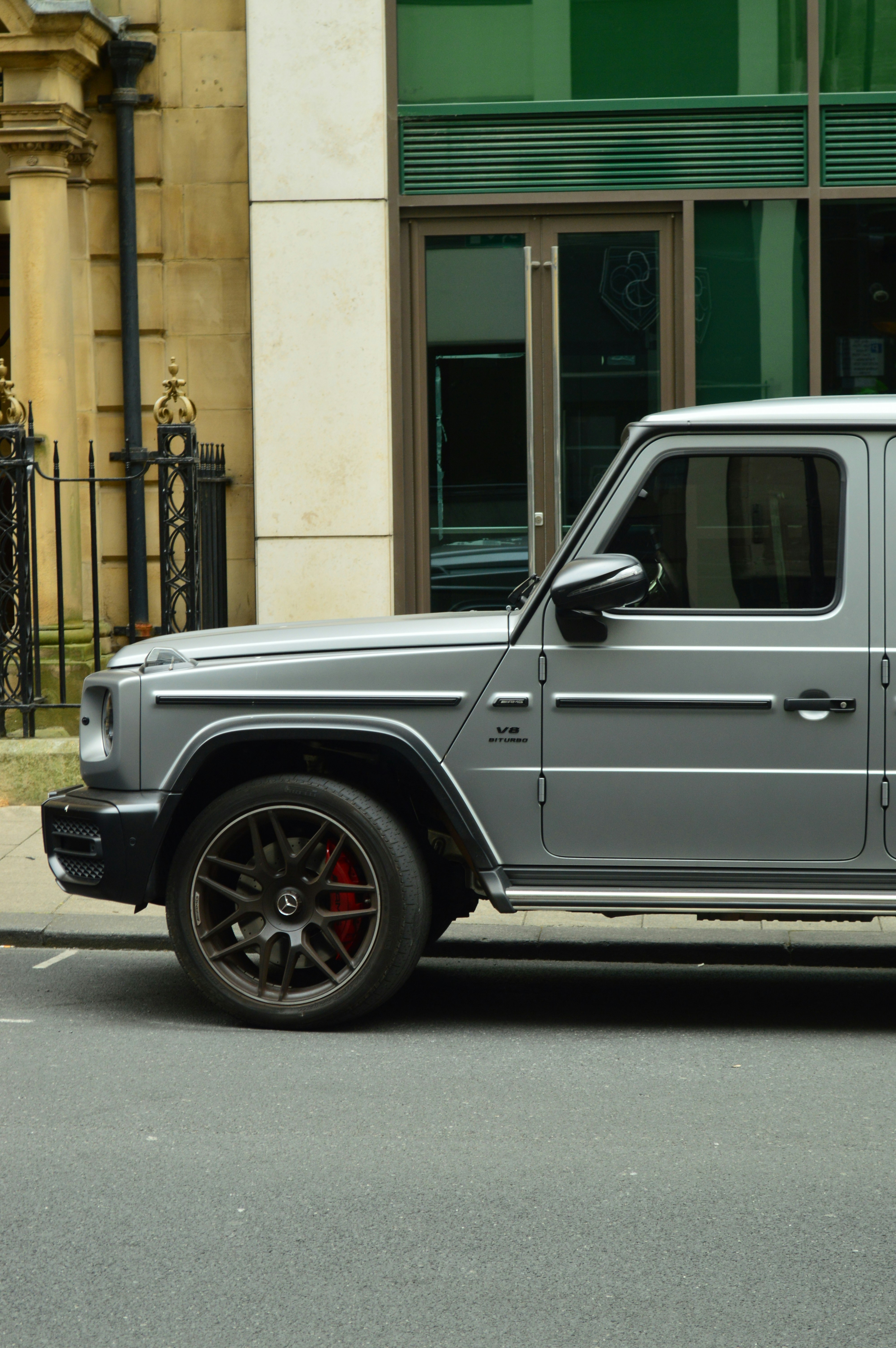 Silver SUV Crowned by Urban Facade