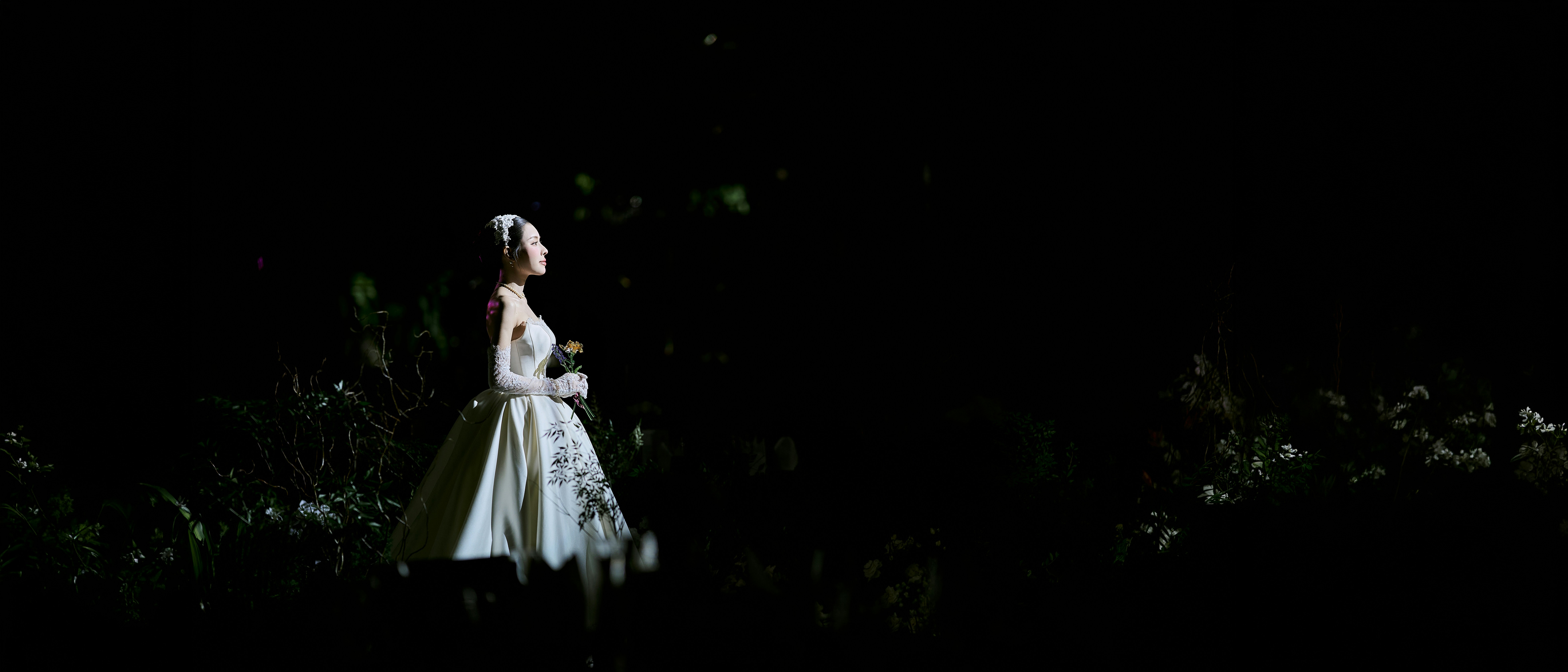 Bride in a Moonlit Garden: A Quiet Moment Under Dark Canopy