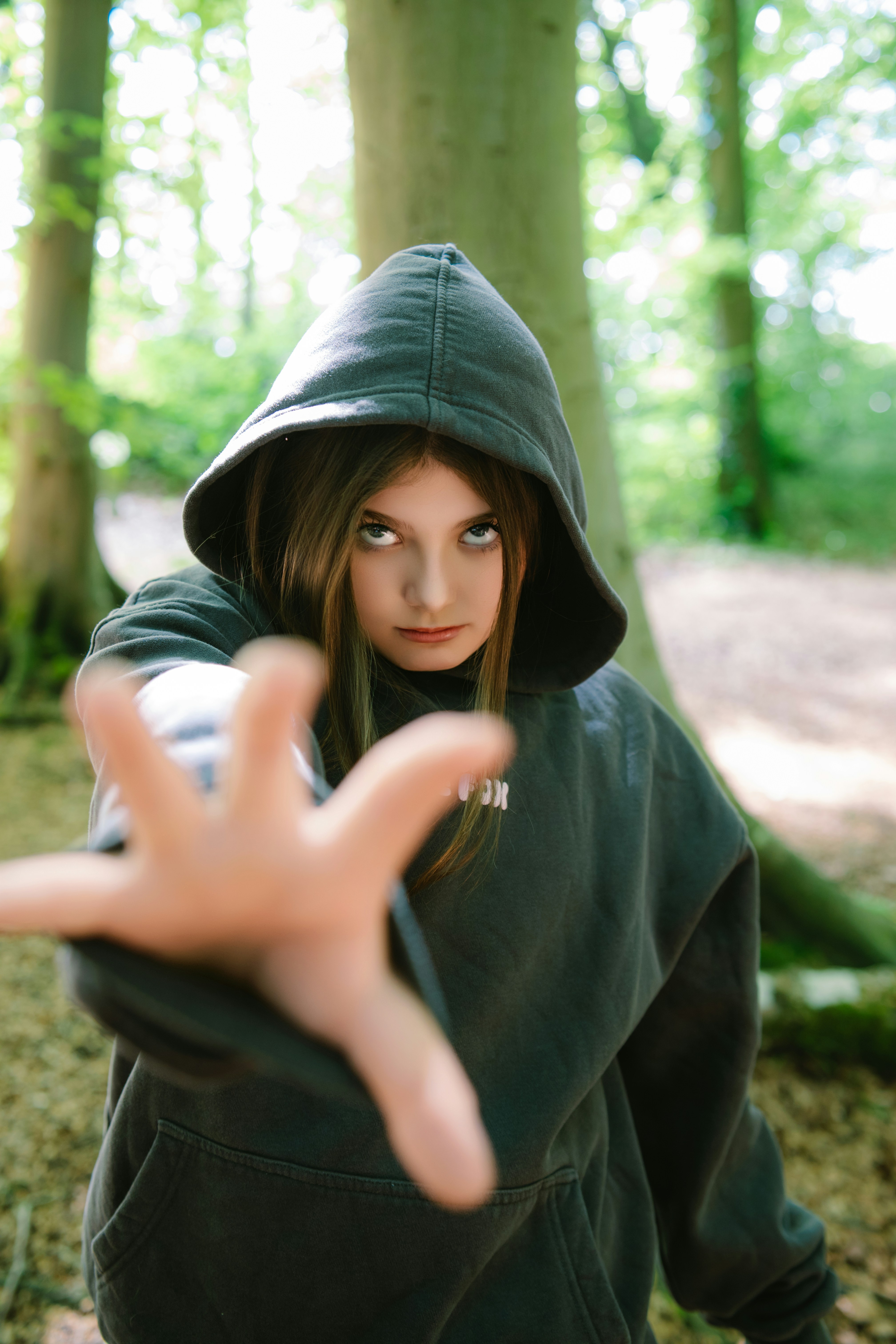 Outstretched Gaze: A Forest Portrait in Hoodie