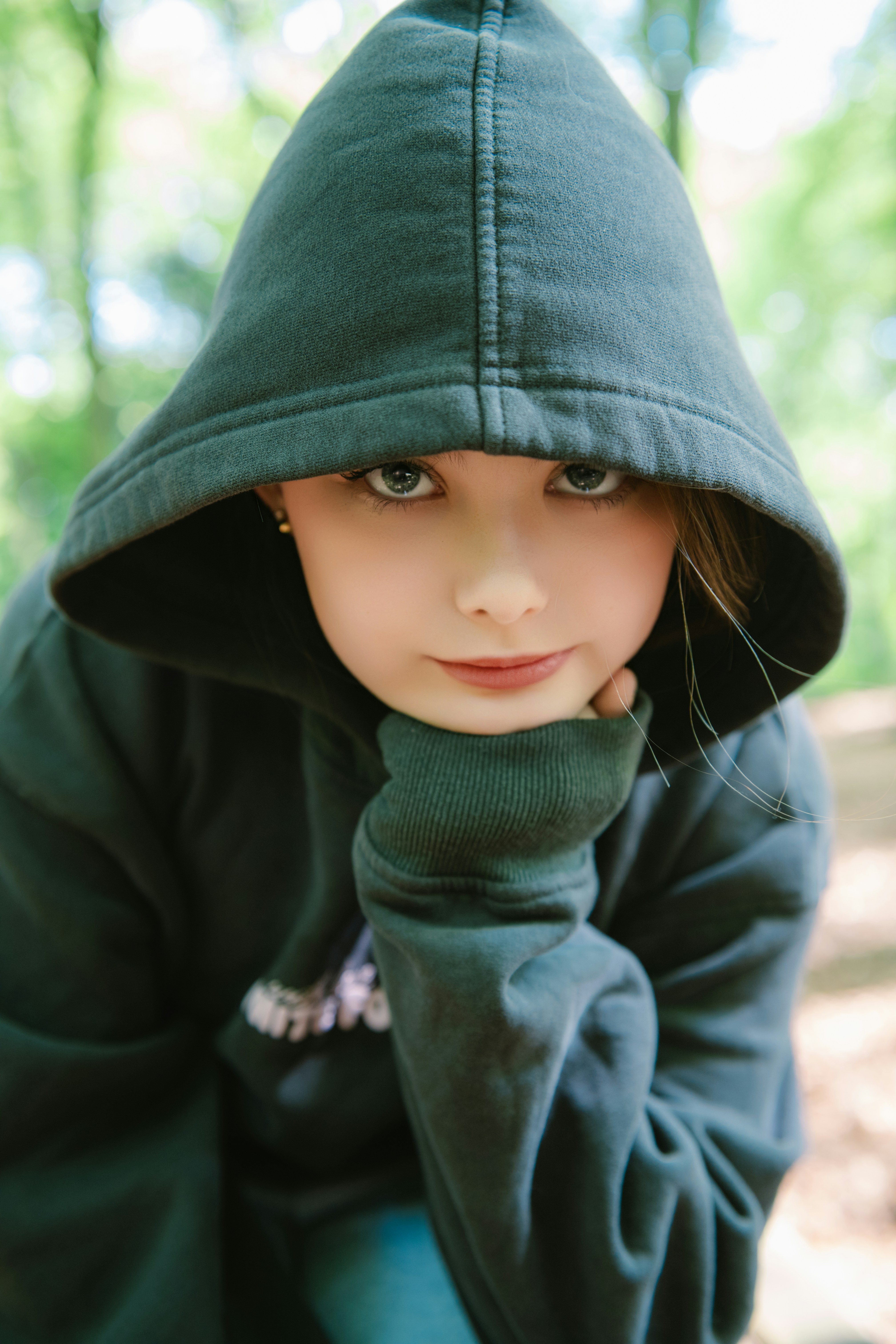 Hooded Portrait: A Quiet Gaze Beneath Forest Light