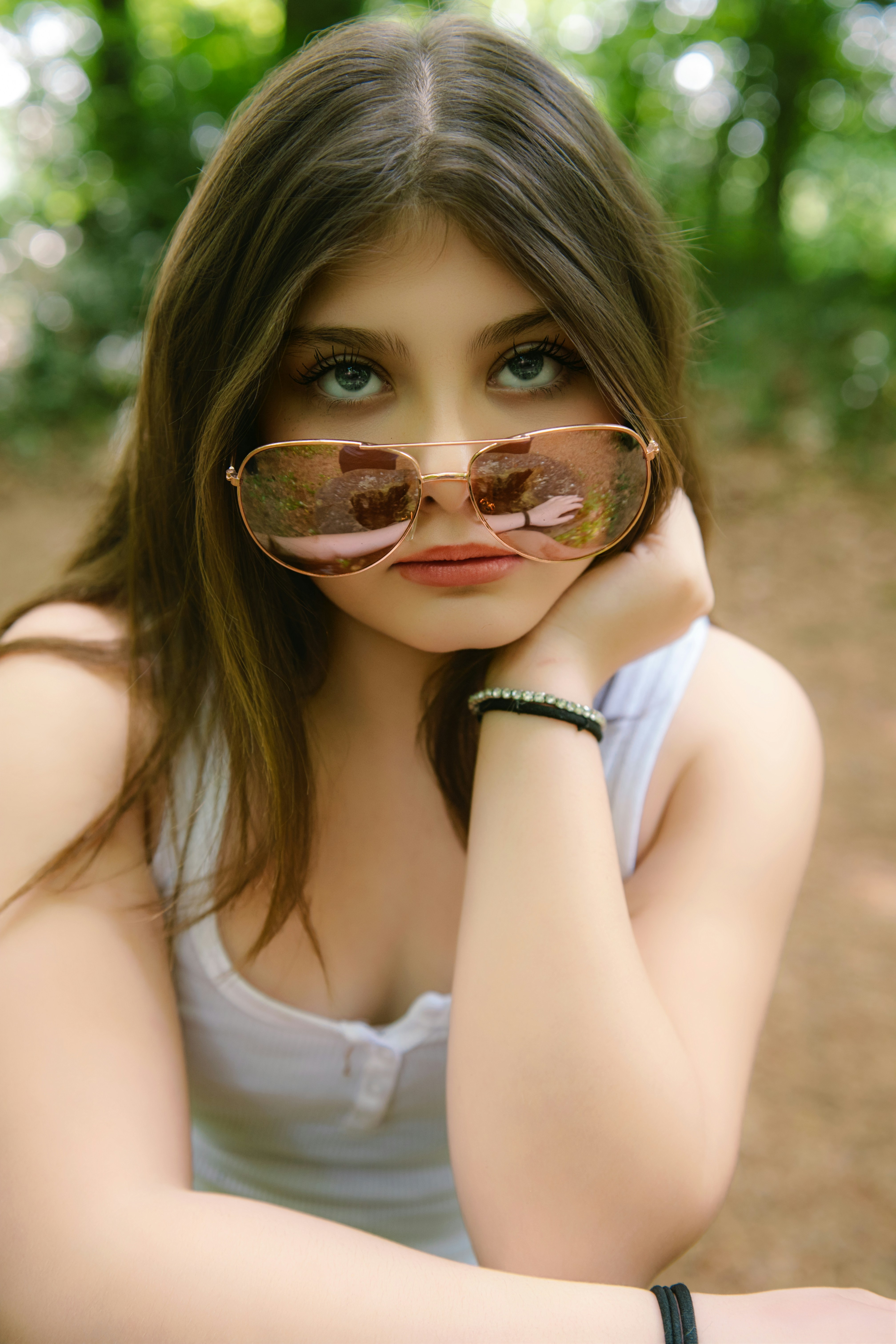 Soft Focus in the Woods: A Girl with Sunglasses in a Quiet Clearing