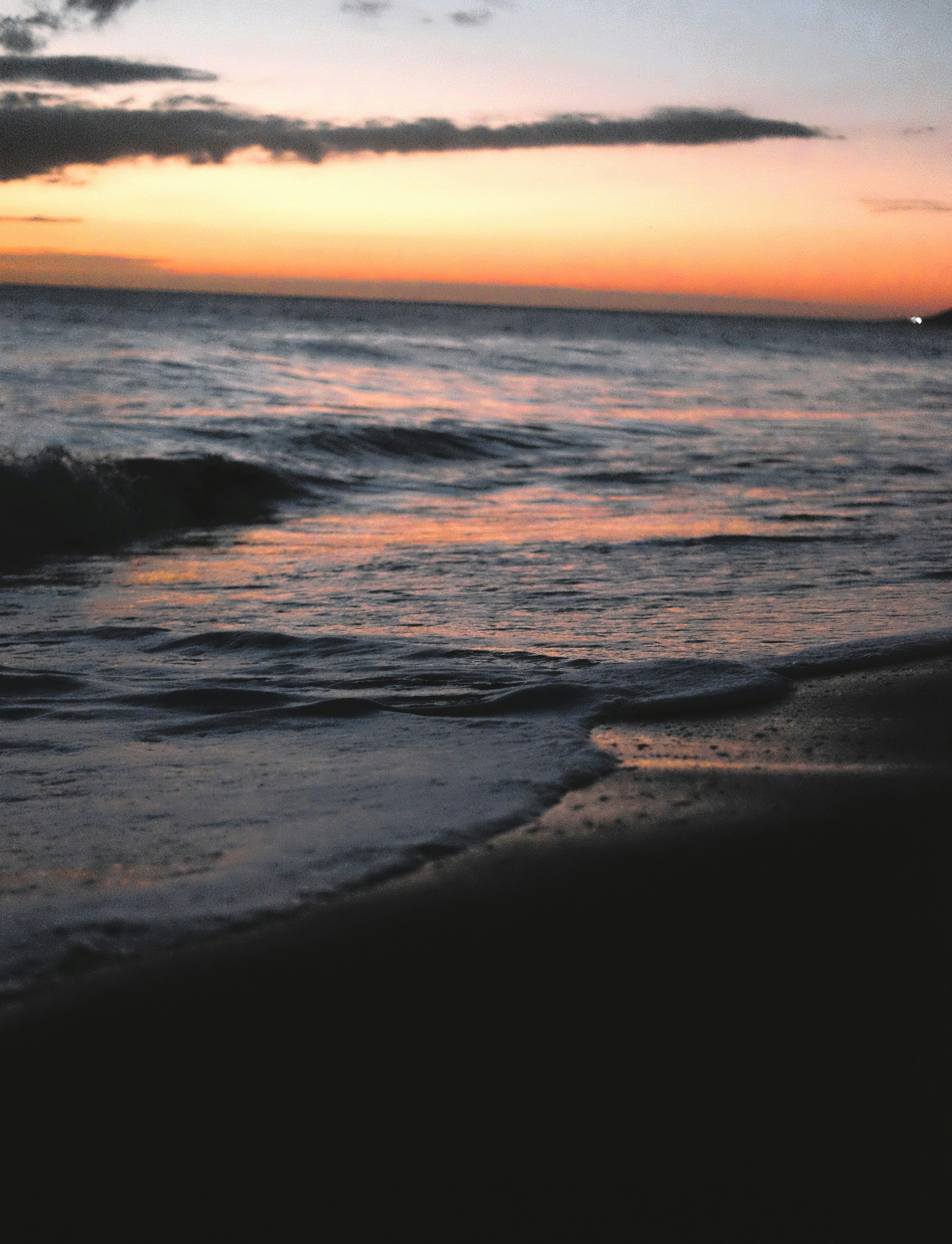 Dusk on the Quiet Shore: Waves Curling toward the Last Light