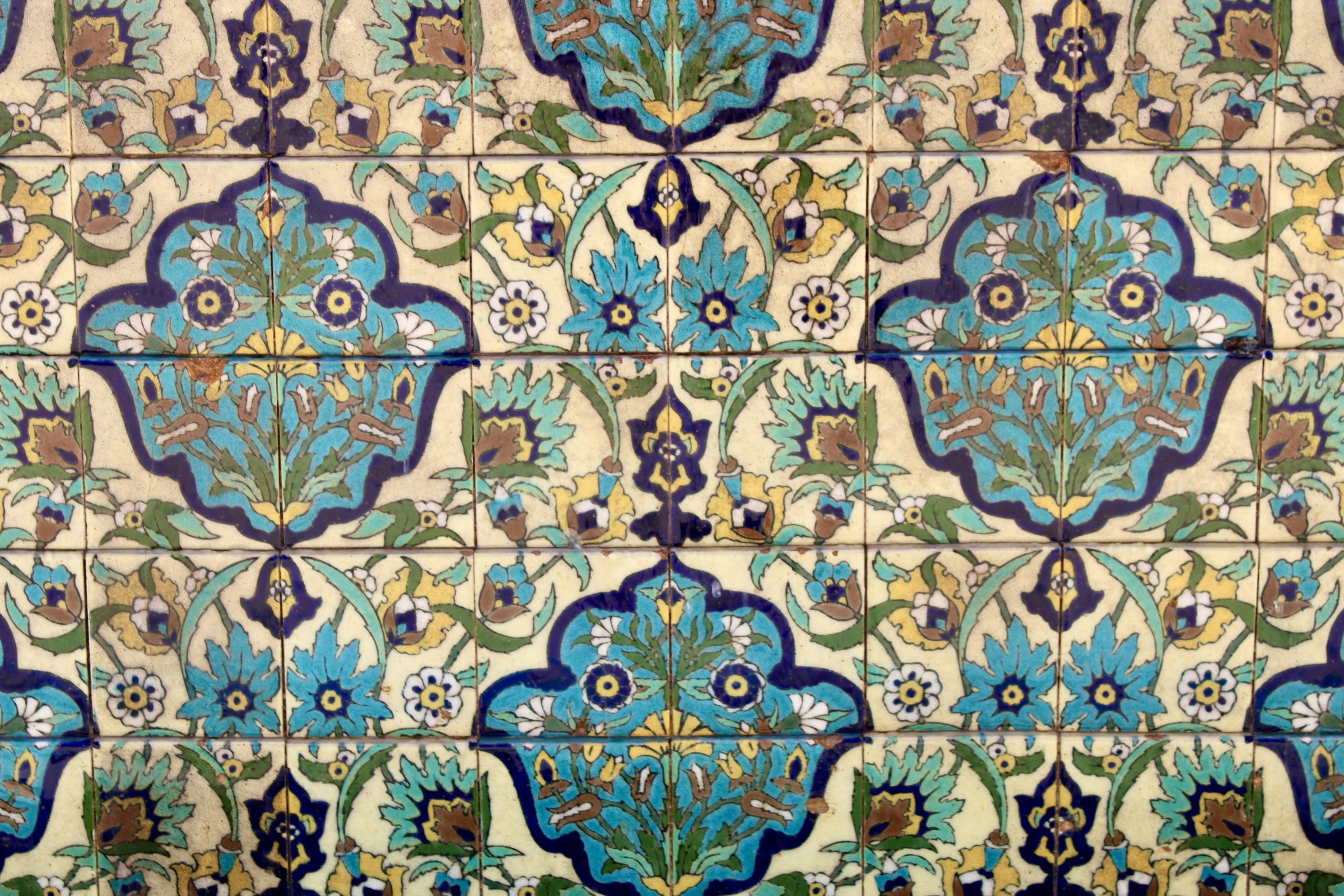 Ornate Tilework: Repeating Turquoise and Indigo Motifs in Ceramic Facade