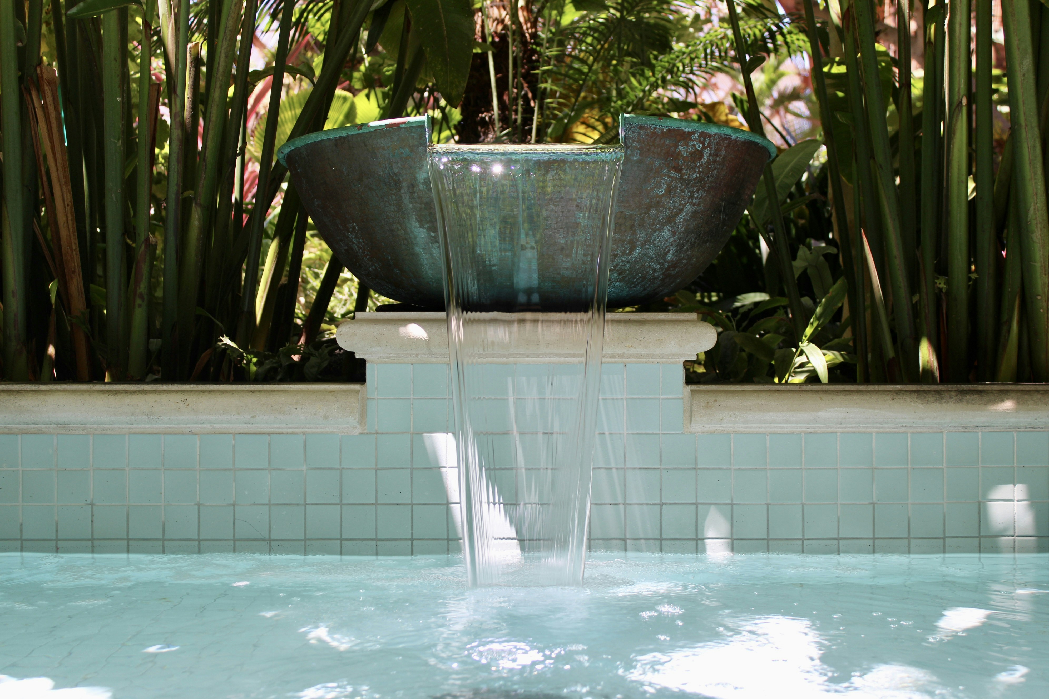Aqua Cascade: Brushed Copper Fountain Above a Mint Tile Bar