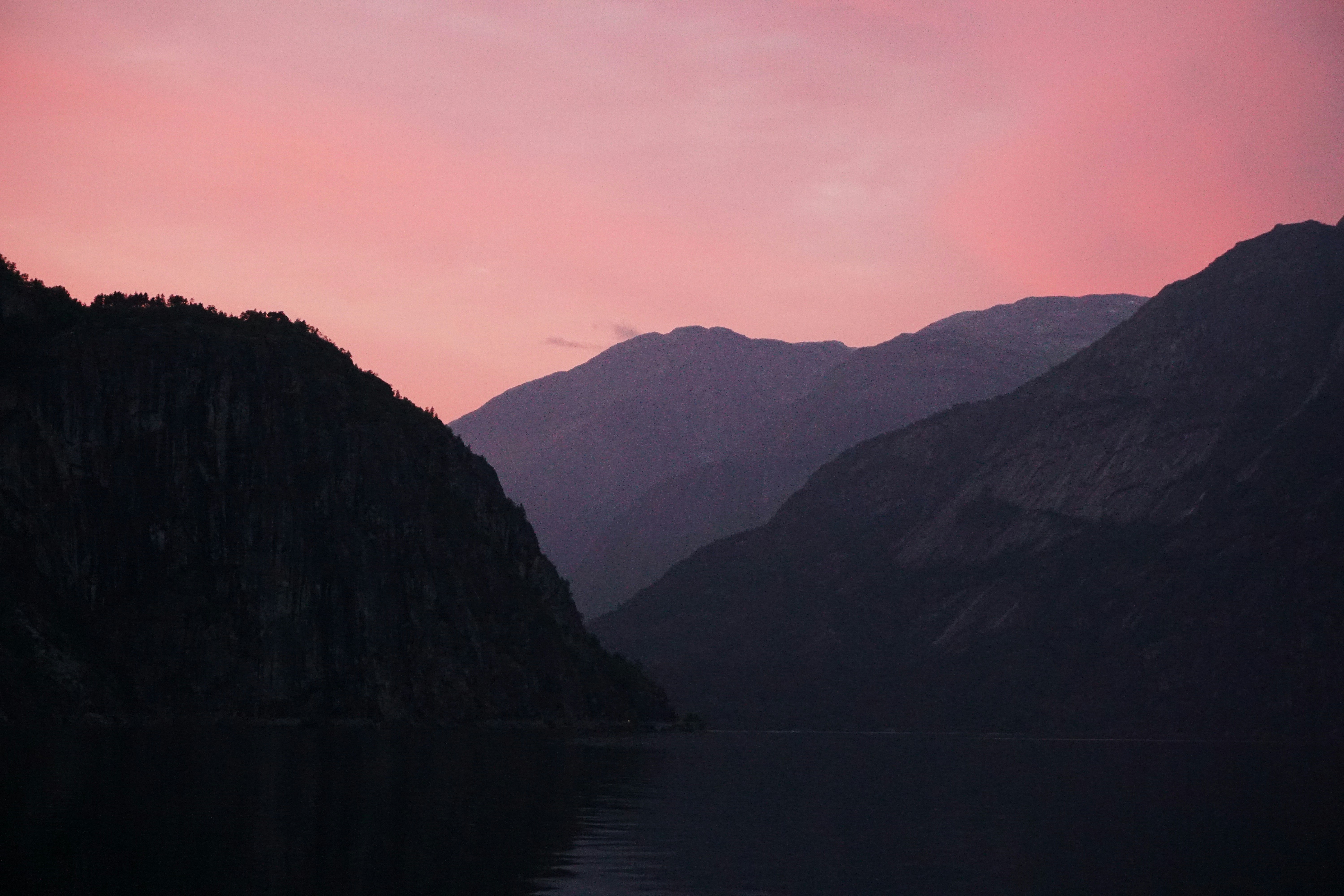 Sunset Fjord: Silent Peaks Beneath a Blush Sky