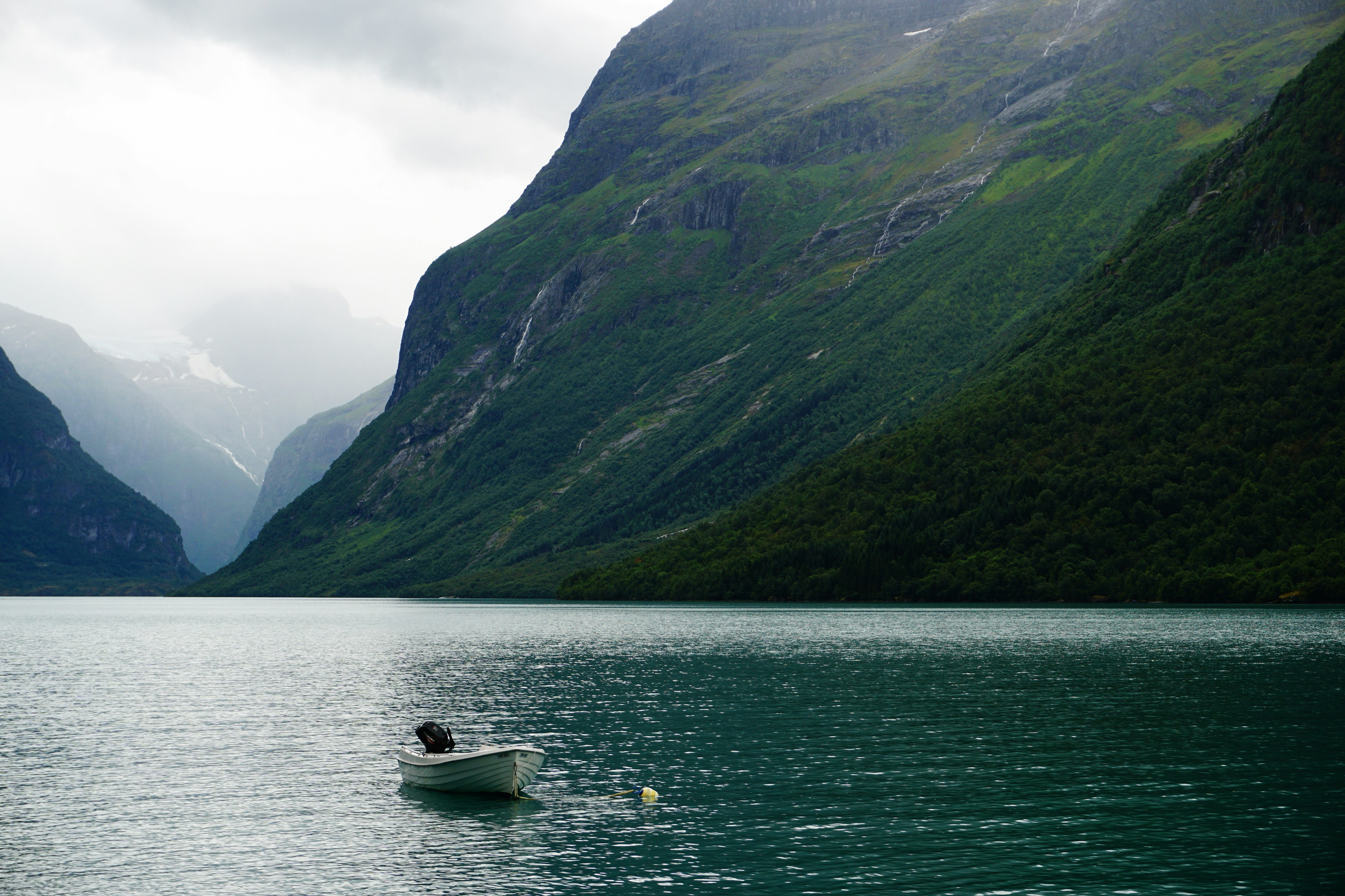 Boat at the Fjord Between Emerald Peaks