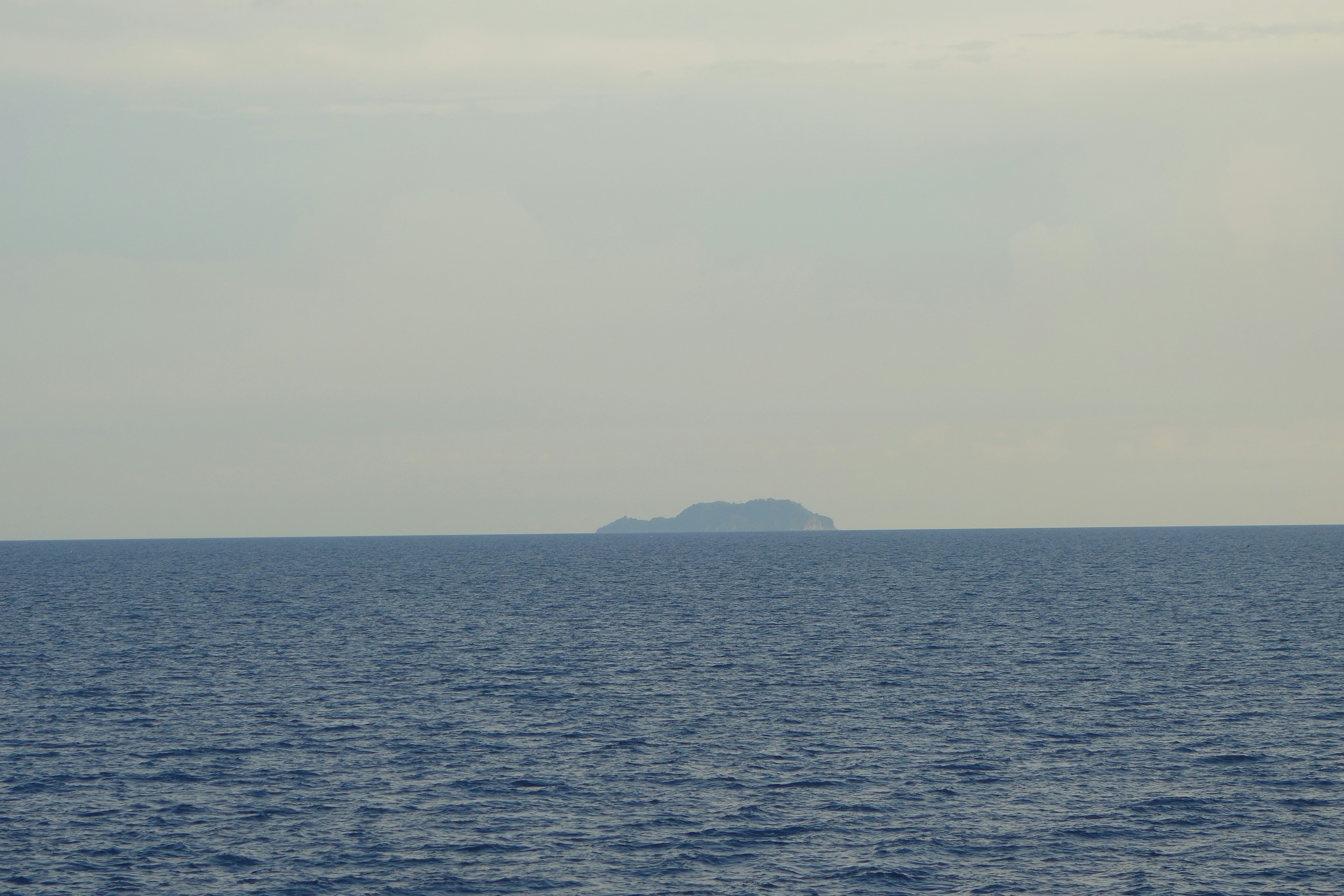 Isolated Island on a Calm Horizon